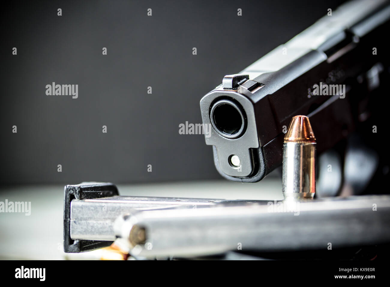 A black pistol hand gun with bullets Stock Photo - Alamy