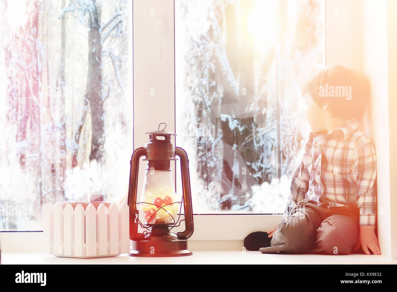 A child in the new year looks out the window. Children are waiti Stock ...