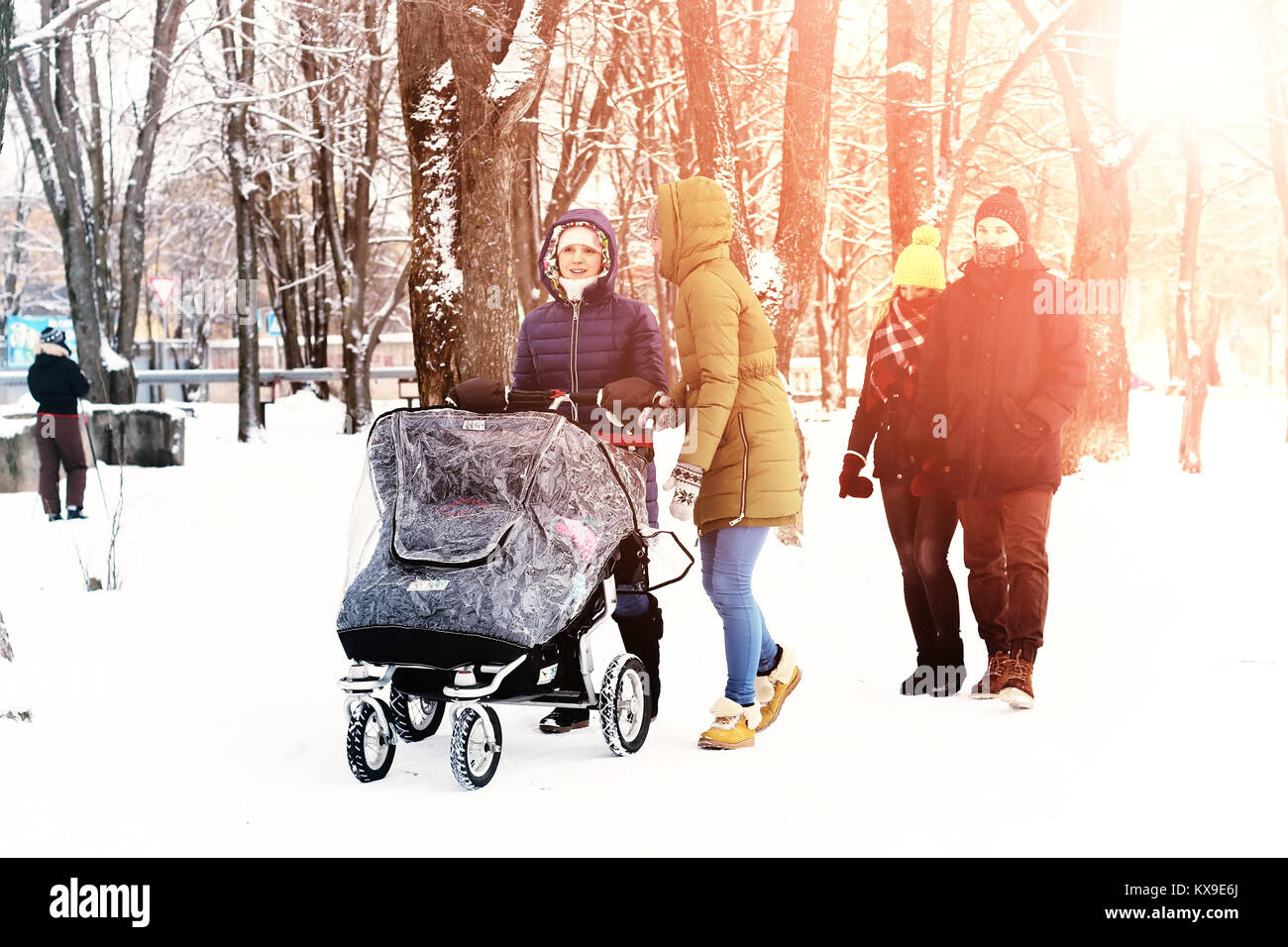 in the winter friends with a stroller Stock Photo - Alamy