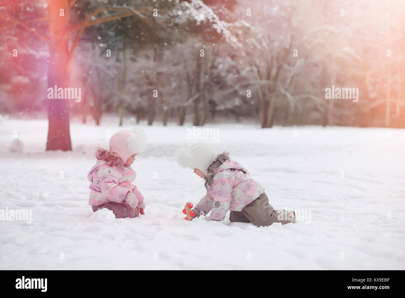 Children walk in the park in winter. Winter forest a family with Stock ...