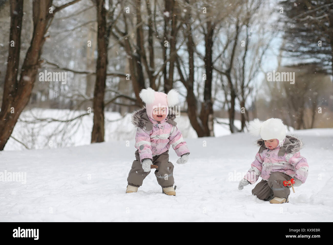Children walk in the park in winter. Winter forest a family with Stock ...
