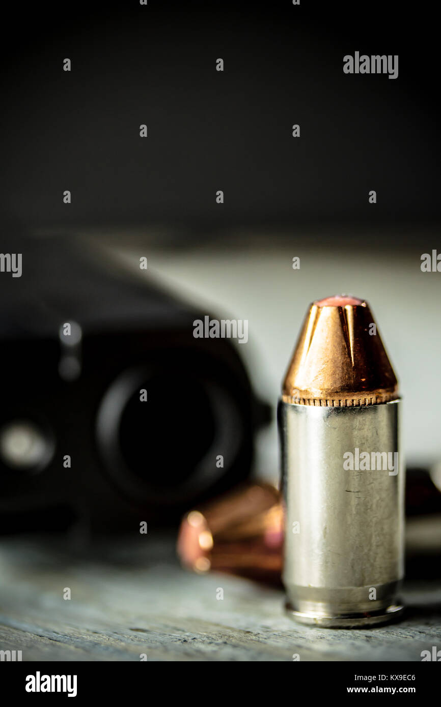 A black pistol hand gun with bullets Stock Photo - Alamy