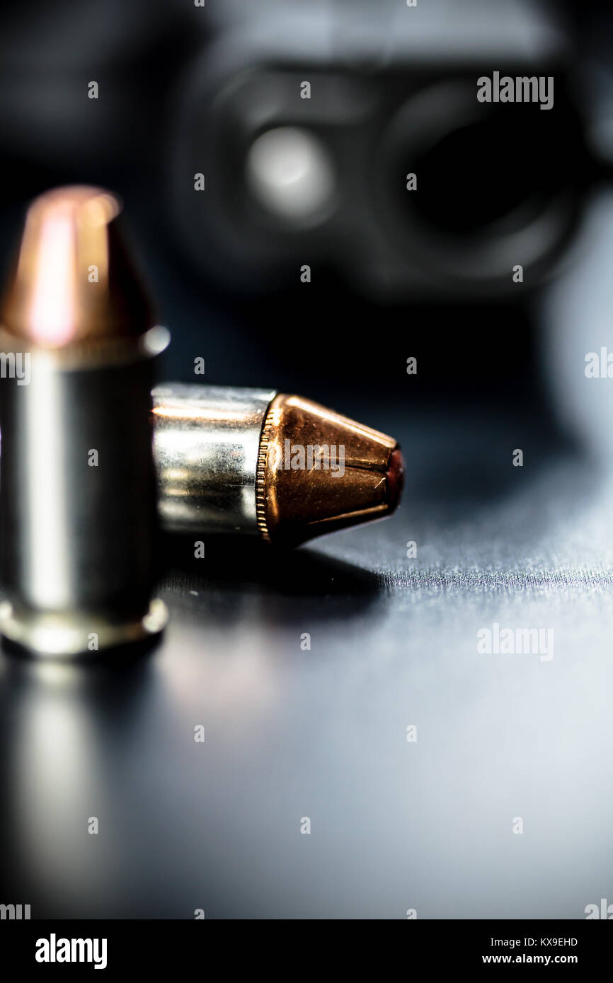 A black pistol hand gun with bullets Stock Photo - Alamy