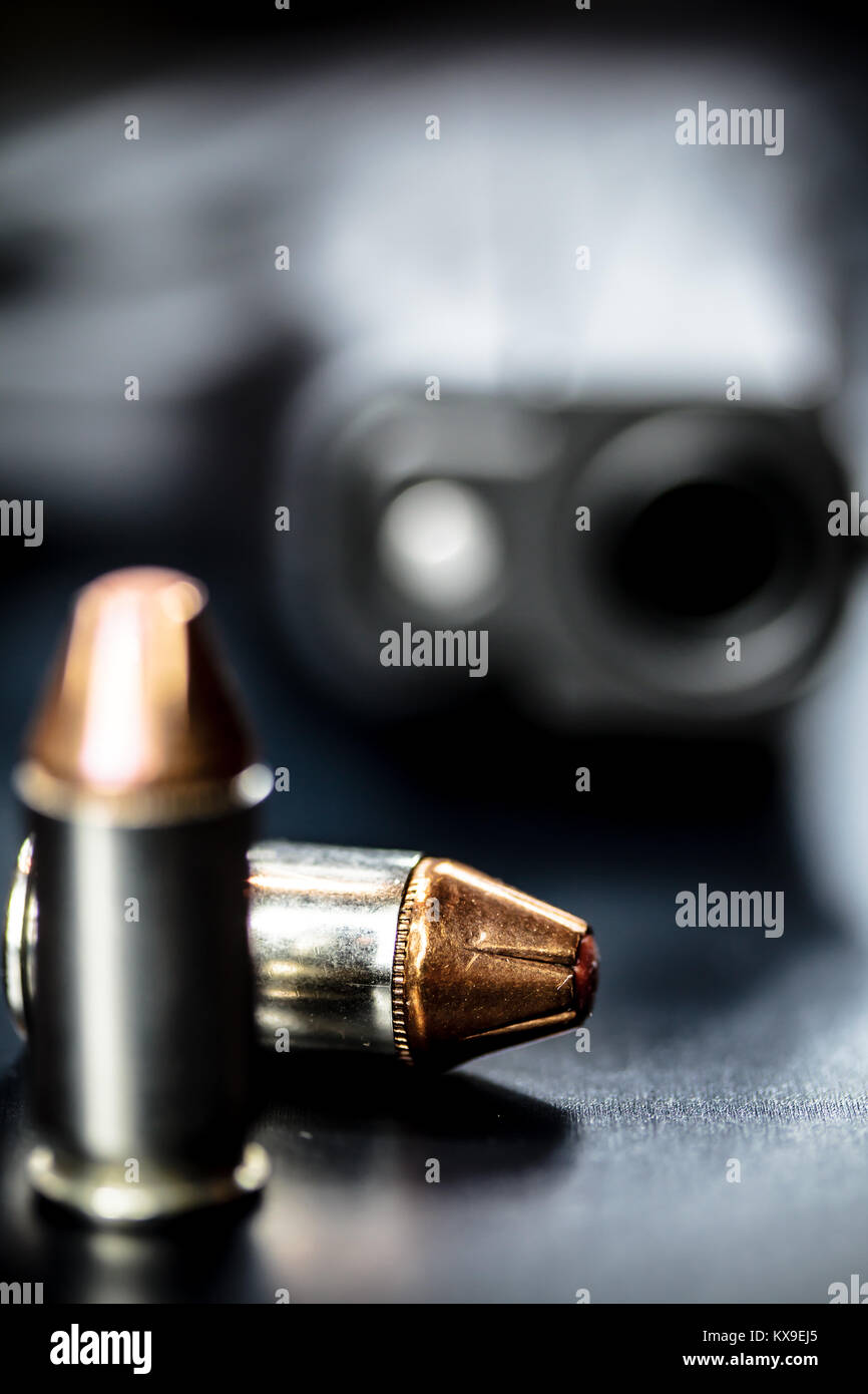 A black pistol hand gun with bullets Stock Photo - Alamy
