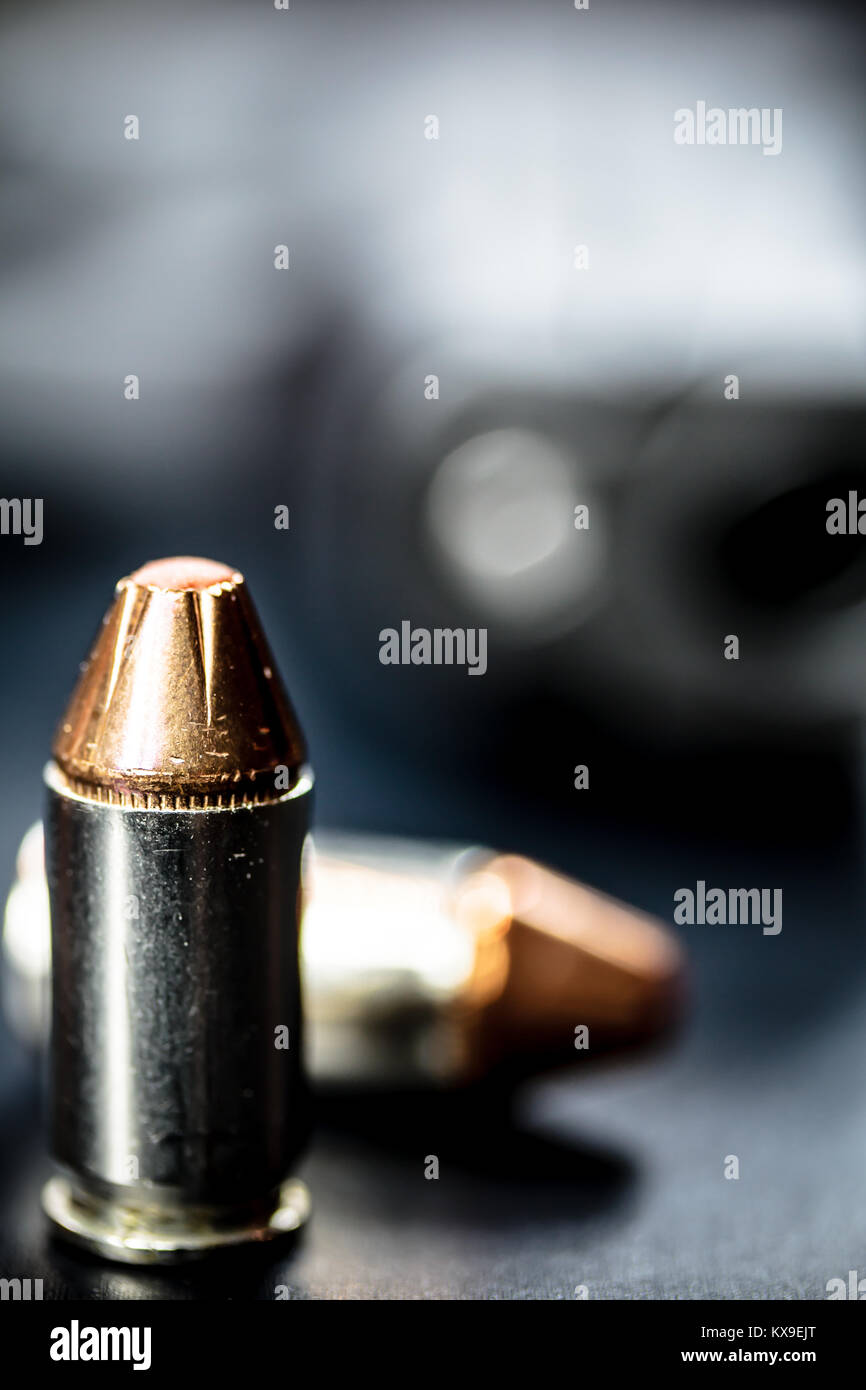 A black pistol hand gun with bullets Stock Photo - Alamy