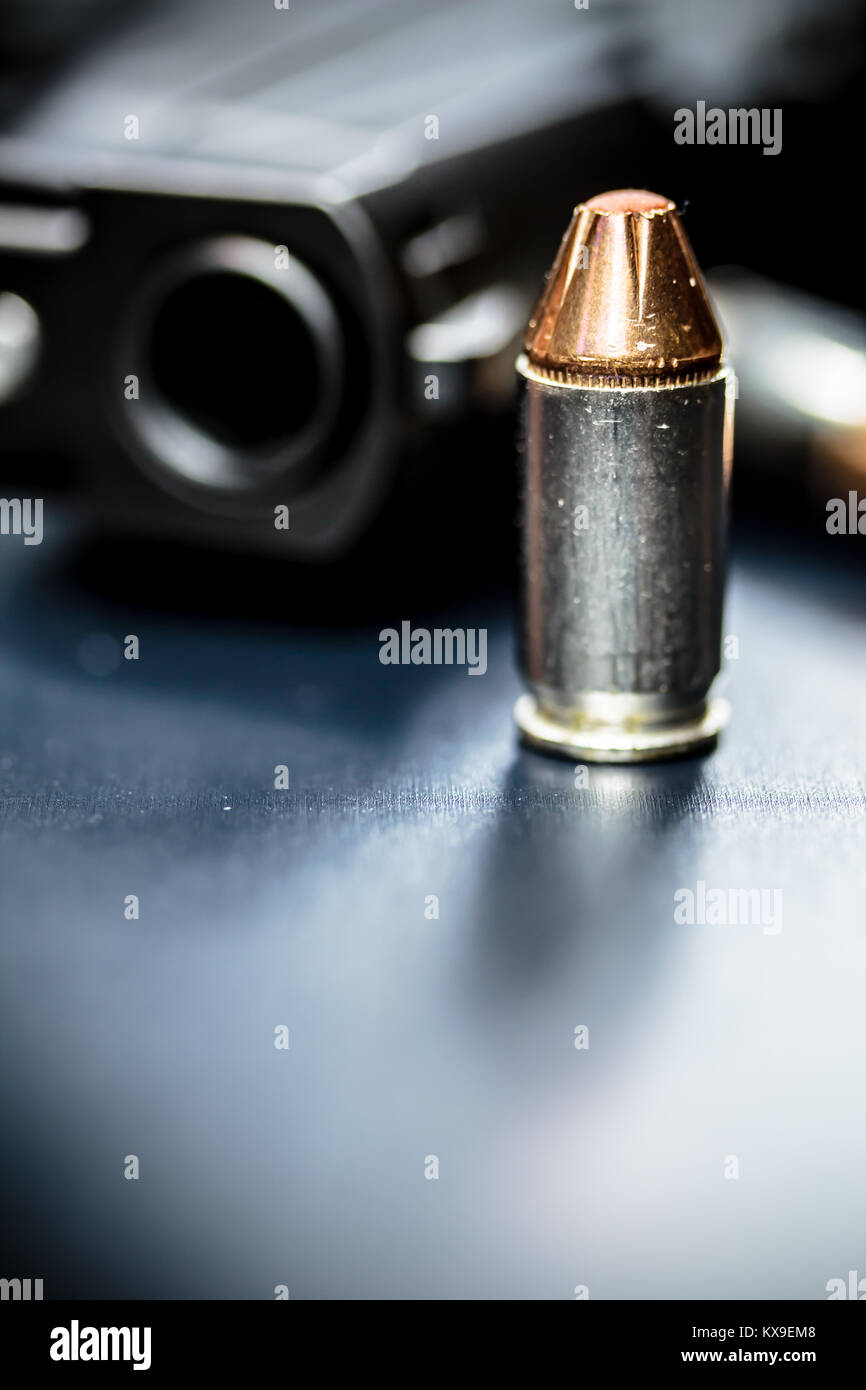 A black pistol hand gun with bullets Stock Photo - Alamy