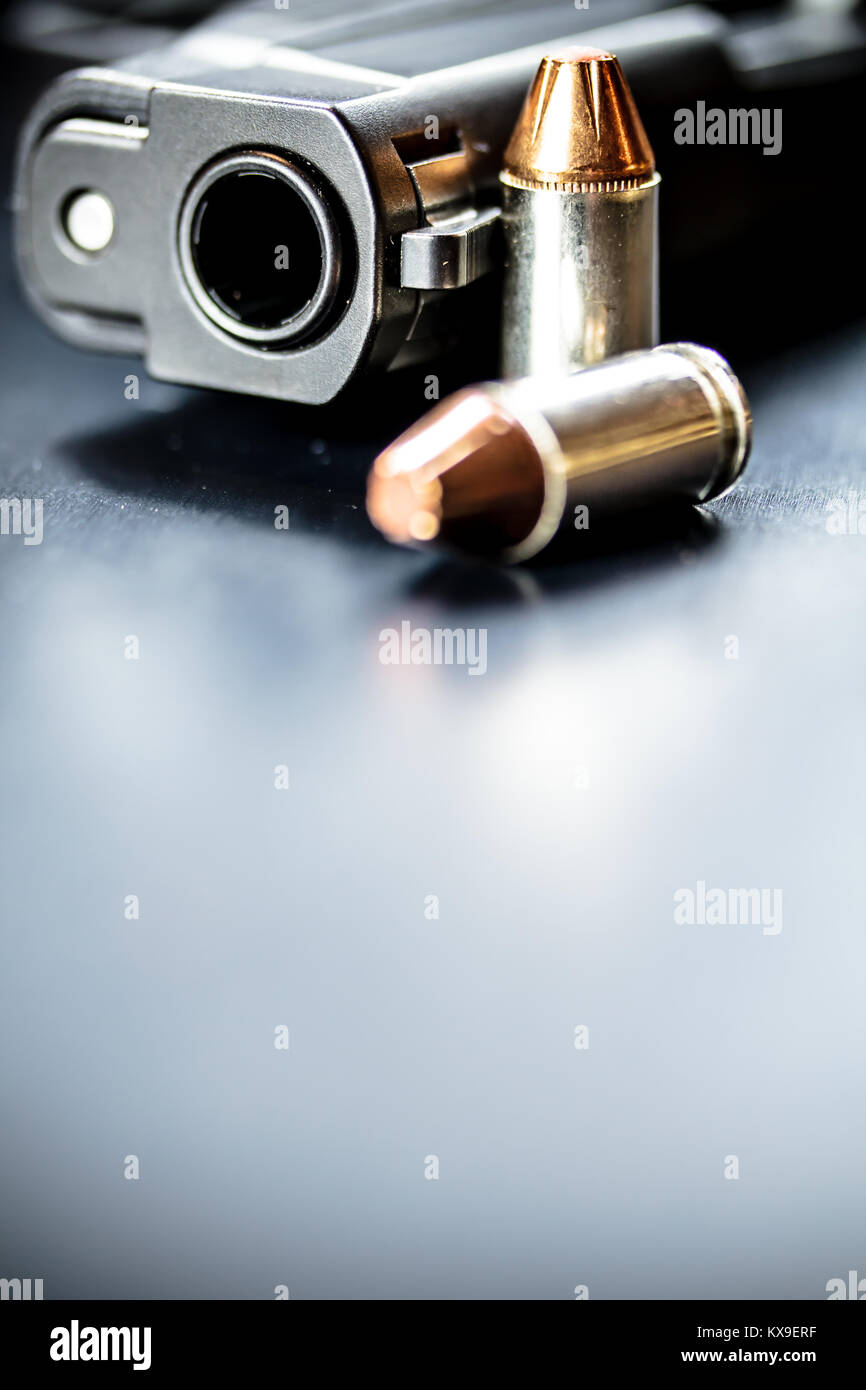 A black pistol hand gun with bullets Stock Photo - Alamy