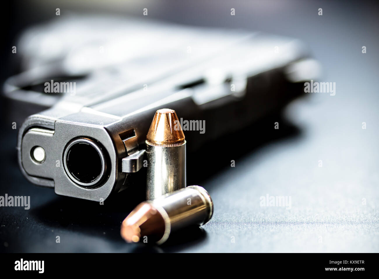 A black pistol hand gun with bullets Stock Photo - Alamy