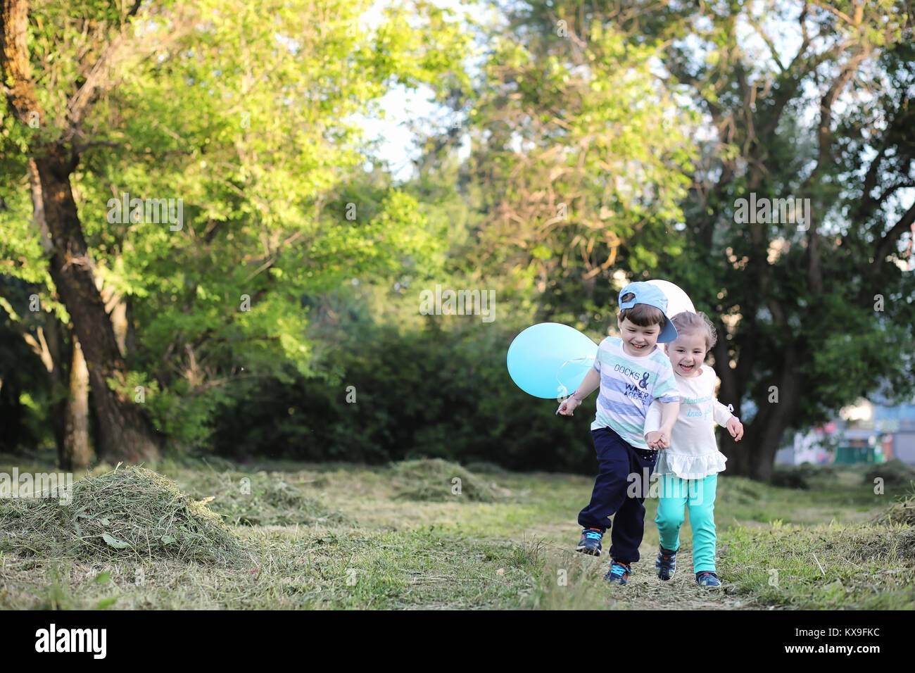Little children are walking in a park Stock Photo - Alamy