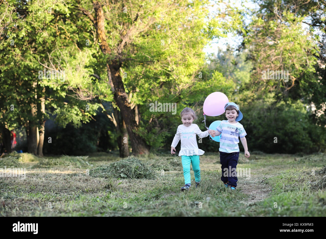 Little children are walking in a park Stock Photo - Alamy