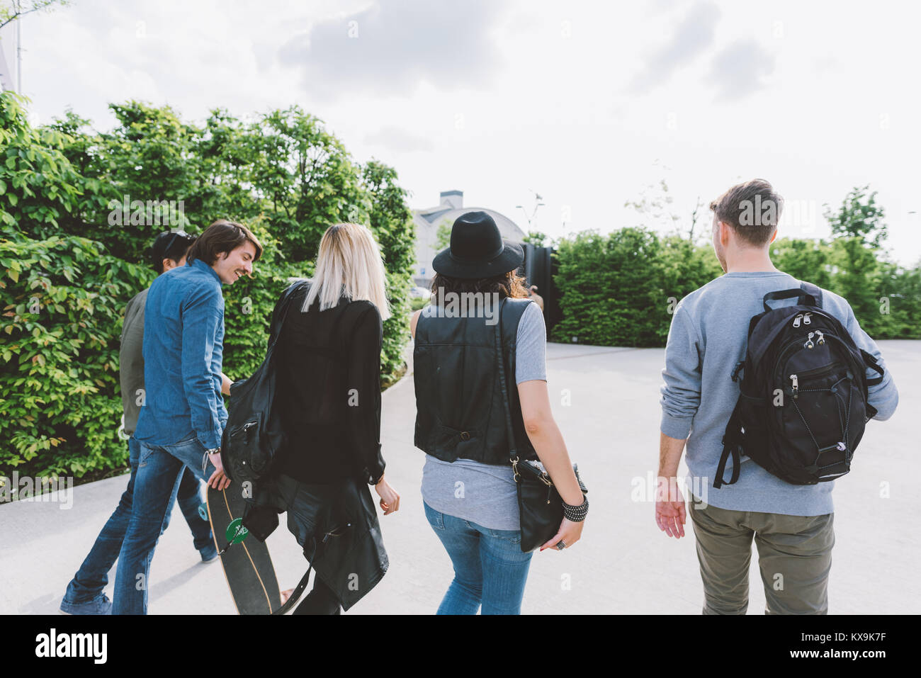 back view group of friends multiethnic walking outdoor having fun ...
