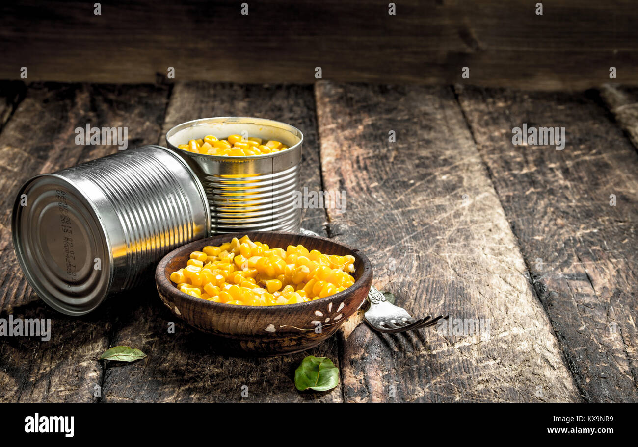Canned corn in a tin can with fork. On a wooden background Stock Photo ...