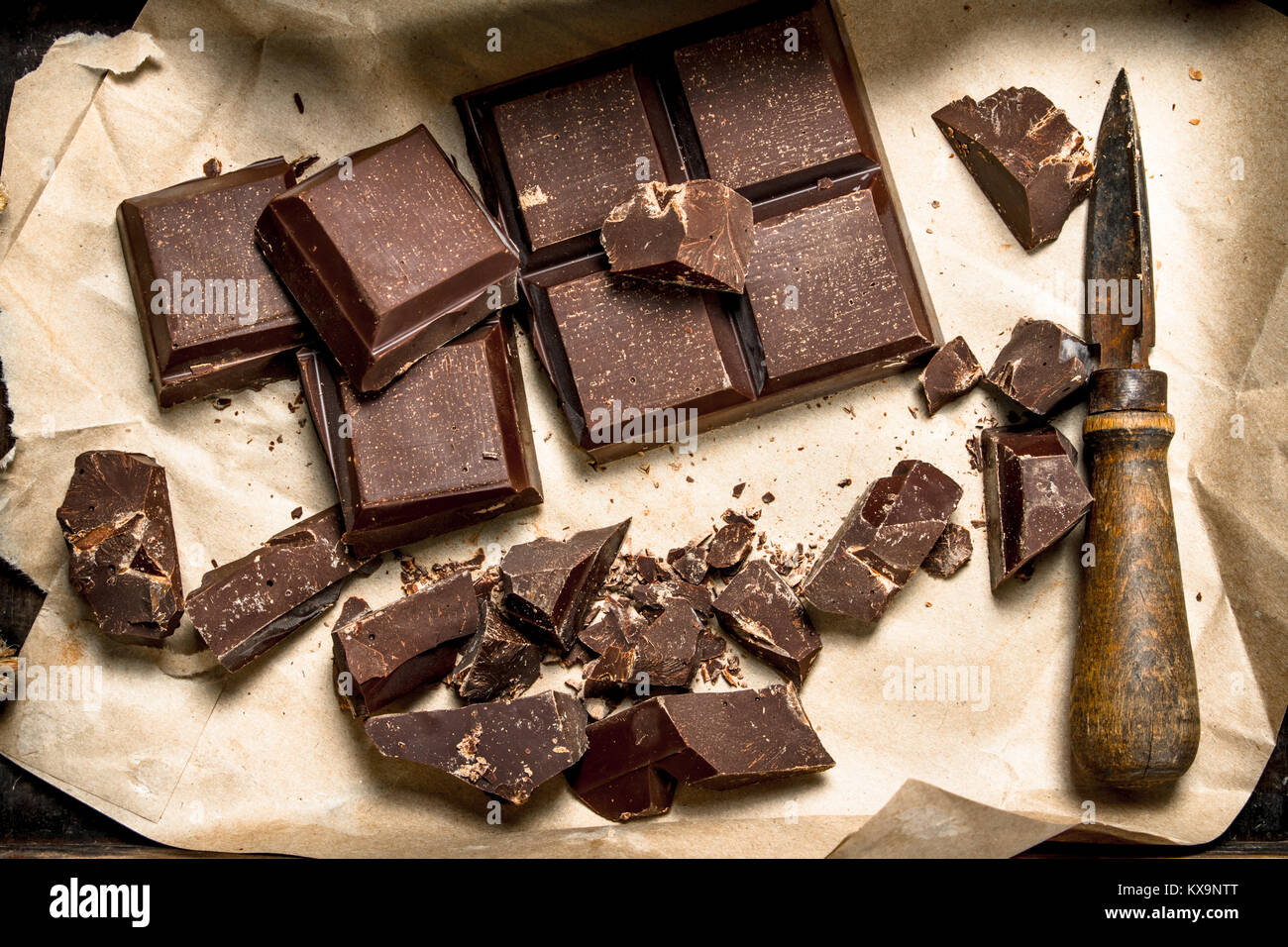 Dark chocolate on old paper. Top view Stock Photo - Alamy