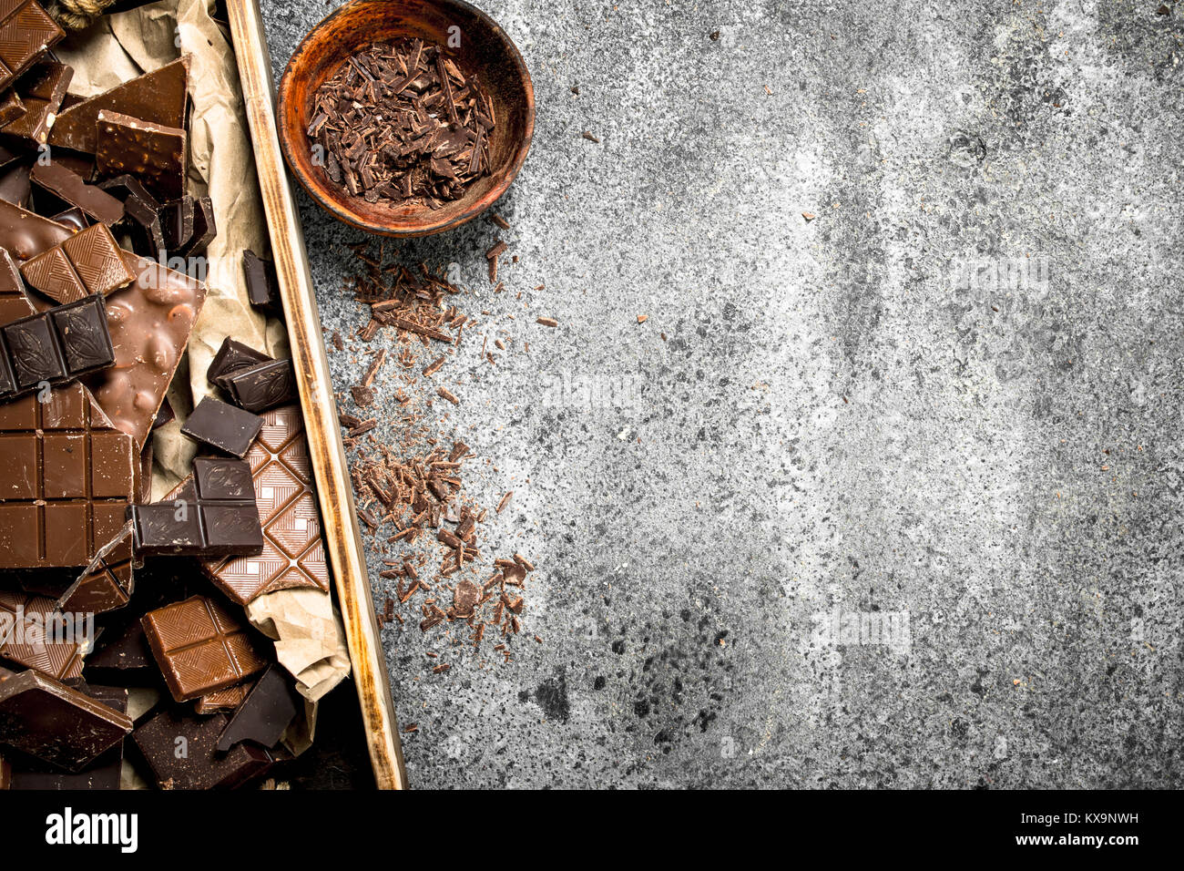 Broken chocolate bars on wooden tray. On a rustic background Stock ...