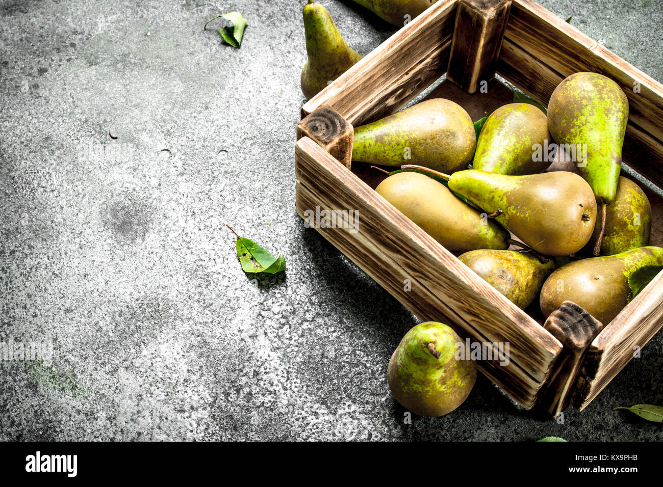 Fresh pears in a box. On a rustic background Stock Photo - Alamy