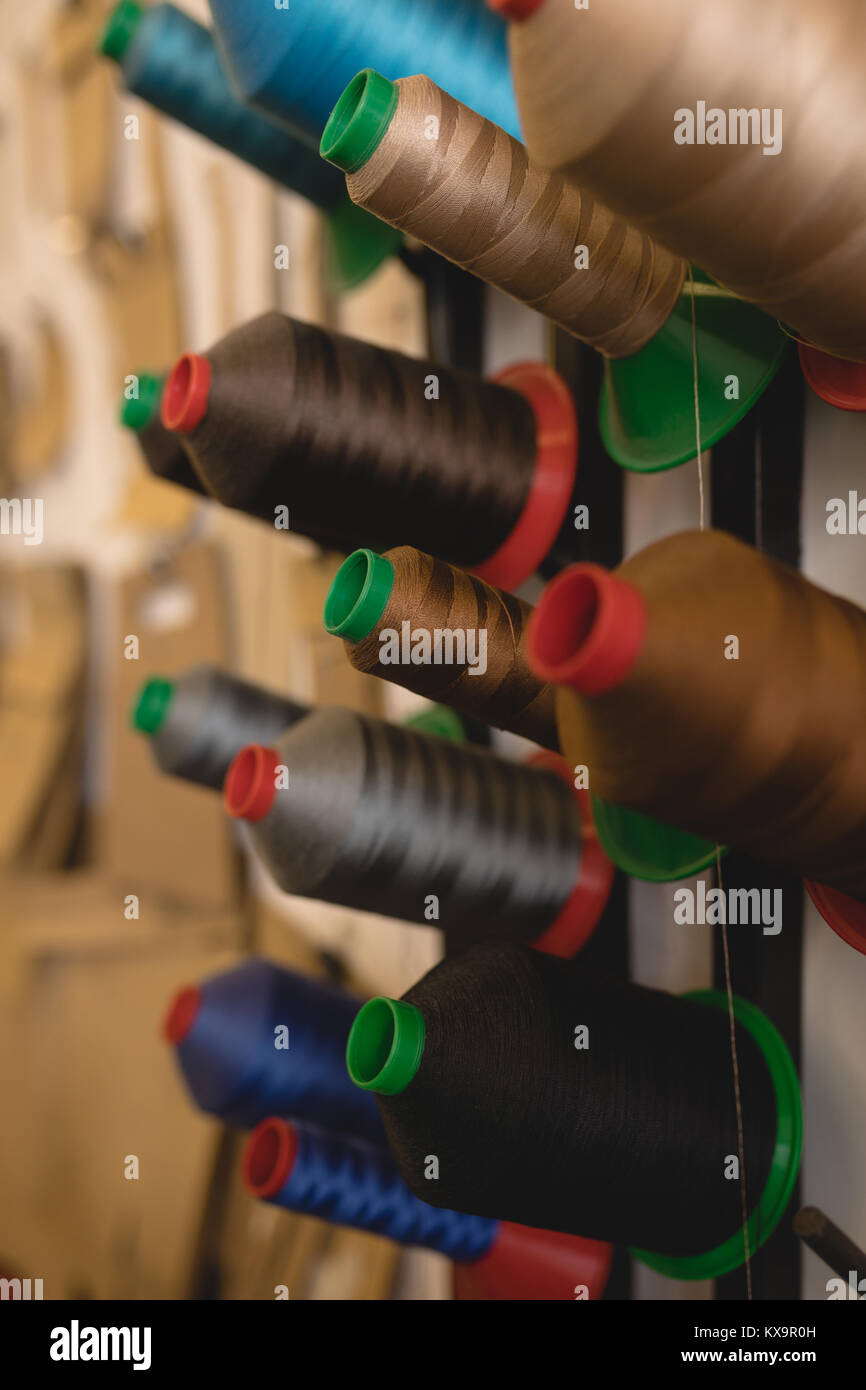 Spool of threads hanging on wall Stock Photo - Alamy