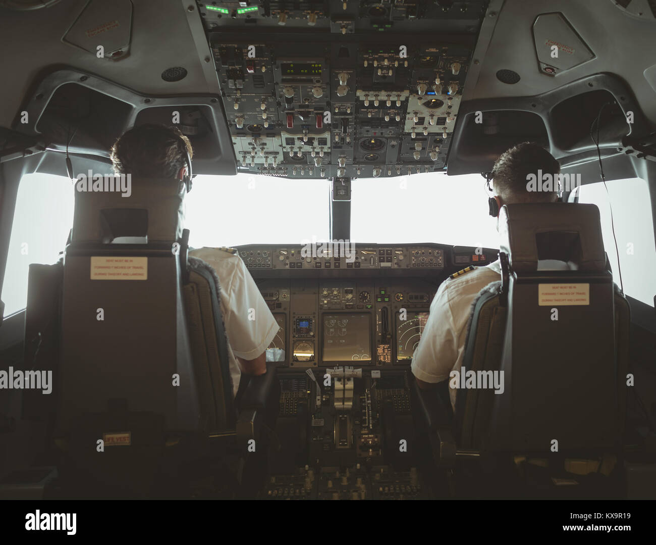 Pilot and copilot flying an airplane Stock Photo - Alamy