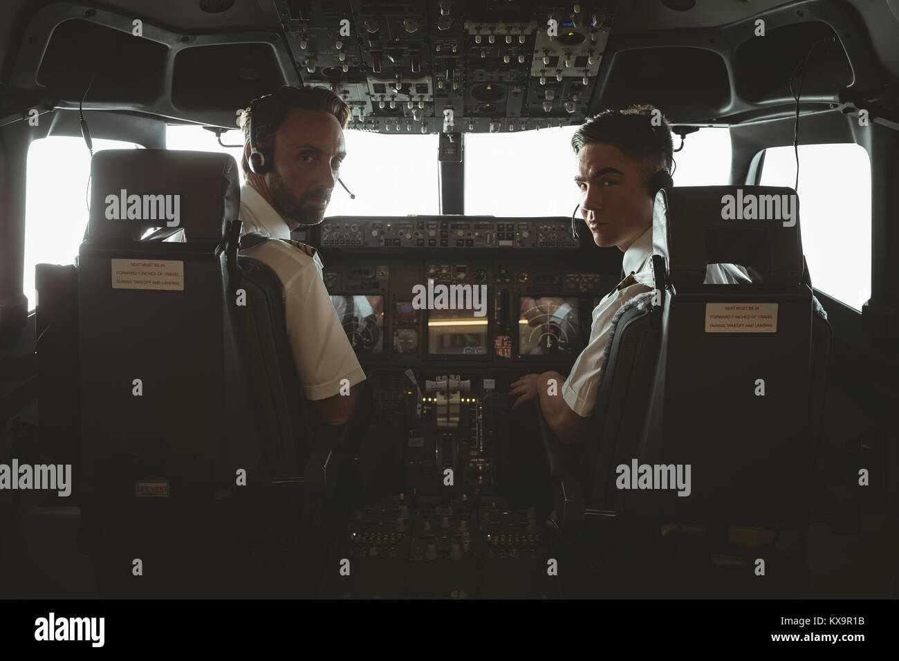 Pilot and copilot flying an airplane Stock Photo - Alamy