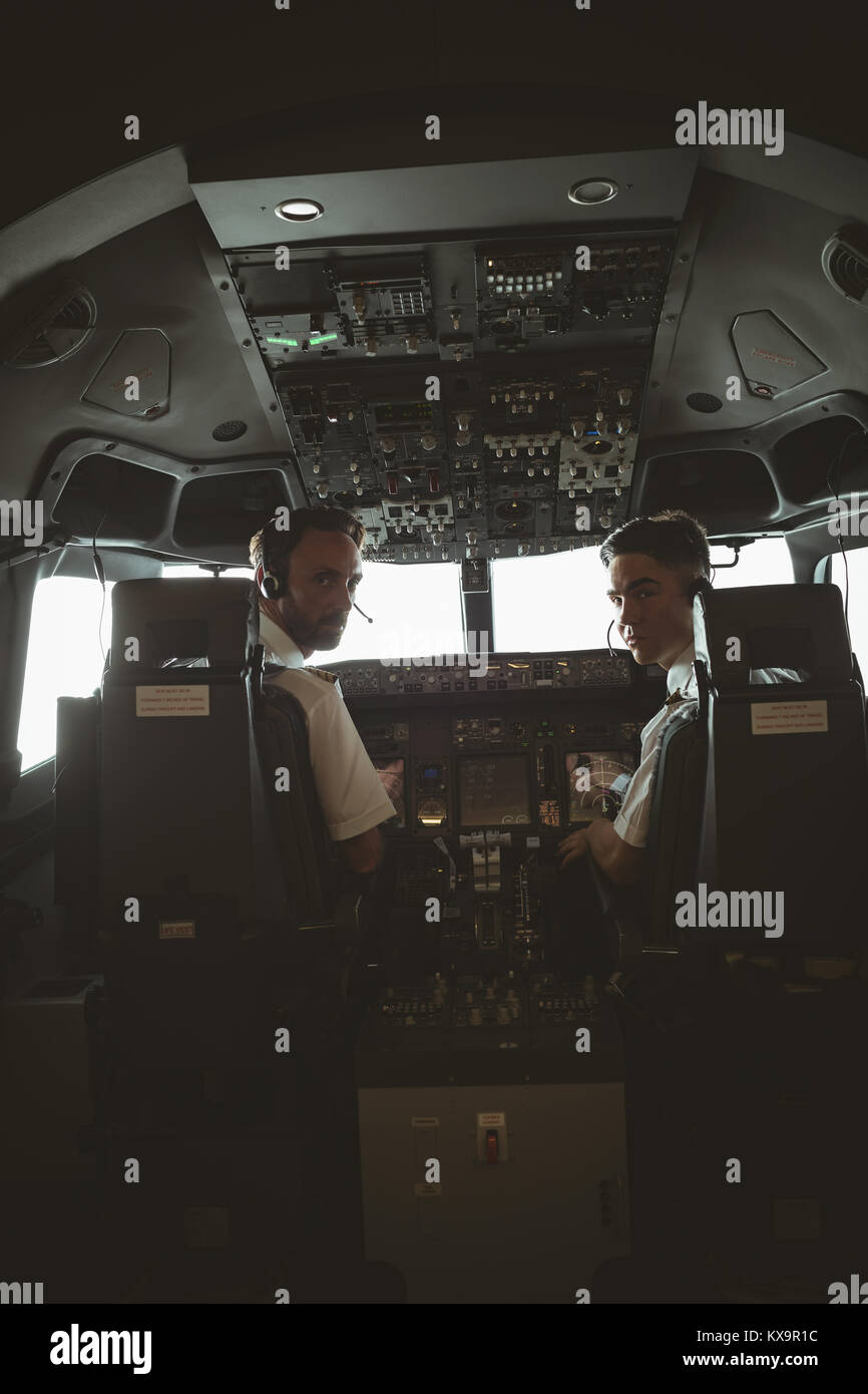 Pilot and copilot flying an airplane Stock Photo - Alamy