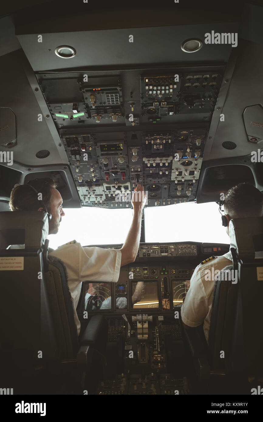Pilot and copilot flying an airplane Stock Photo - Alamy
