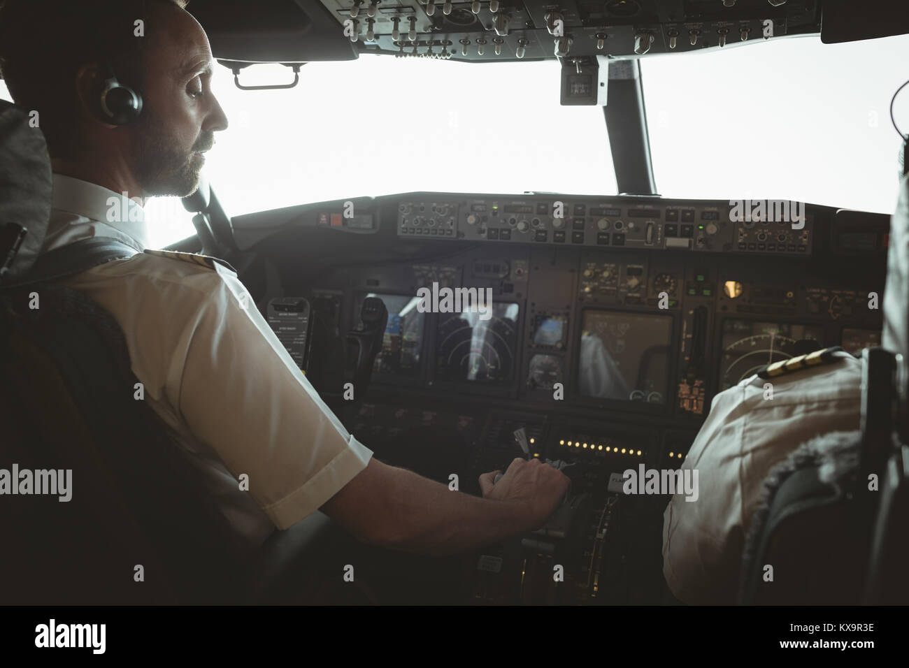 Pilot and copilot flying an airplane Stock Photo - Alamy