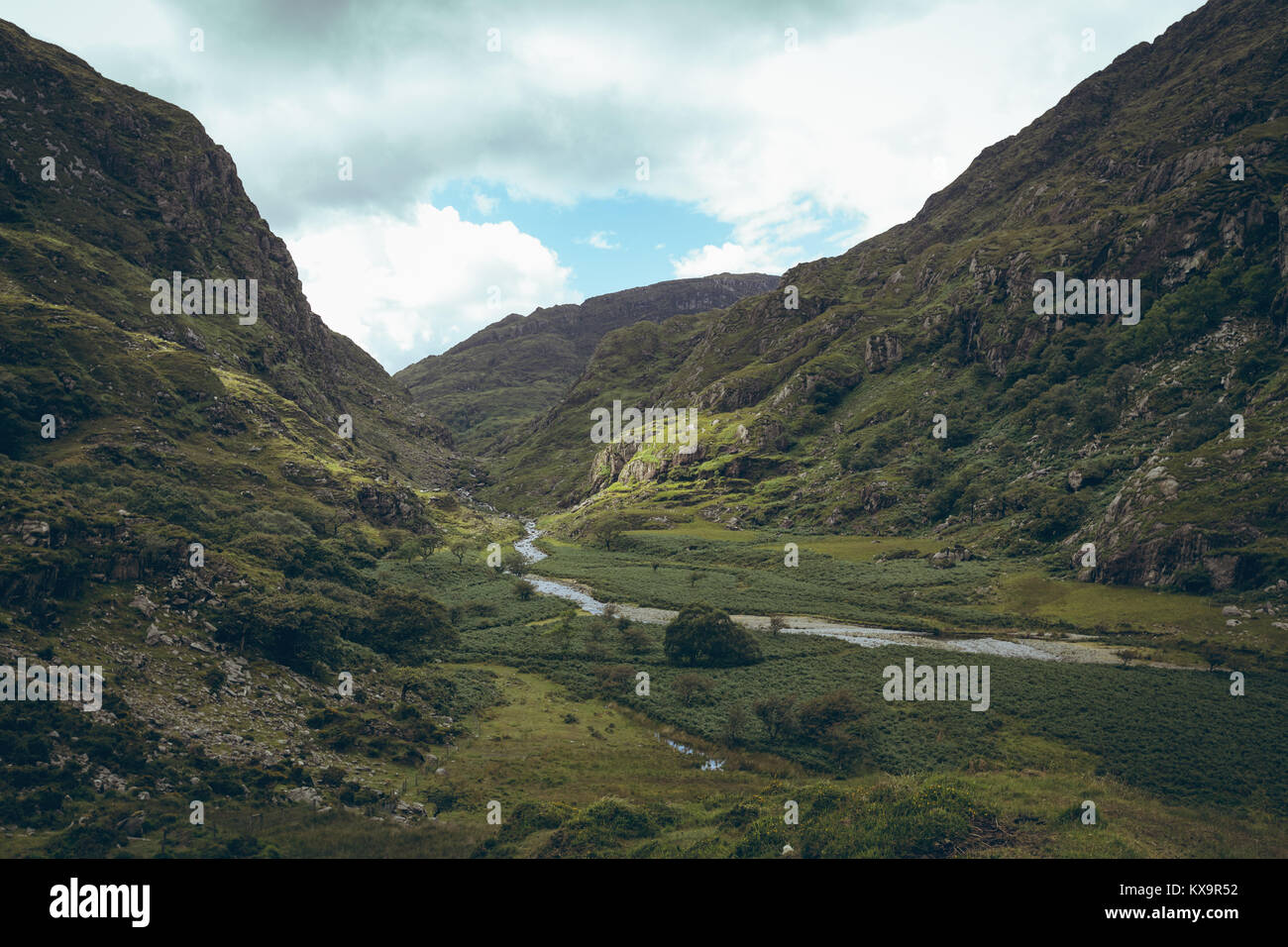 Mountains and stream flowing on countryside landscape Stock Photo - Alamy