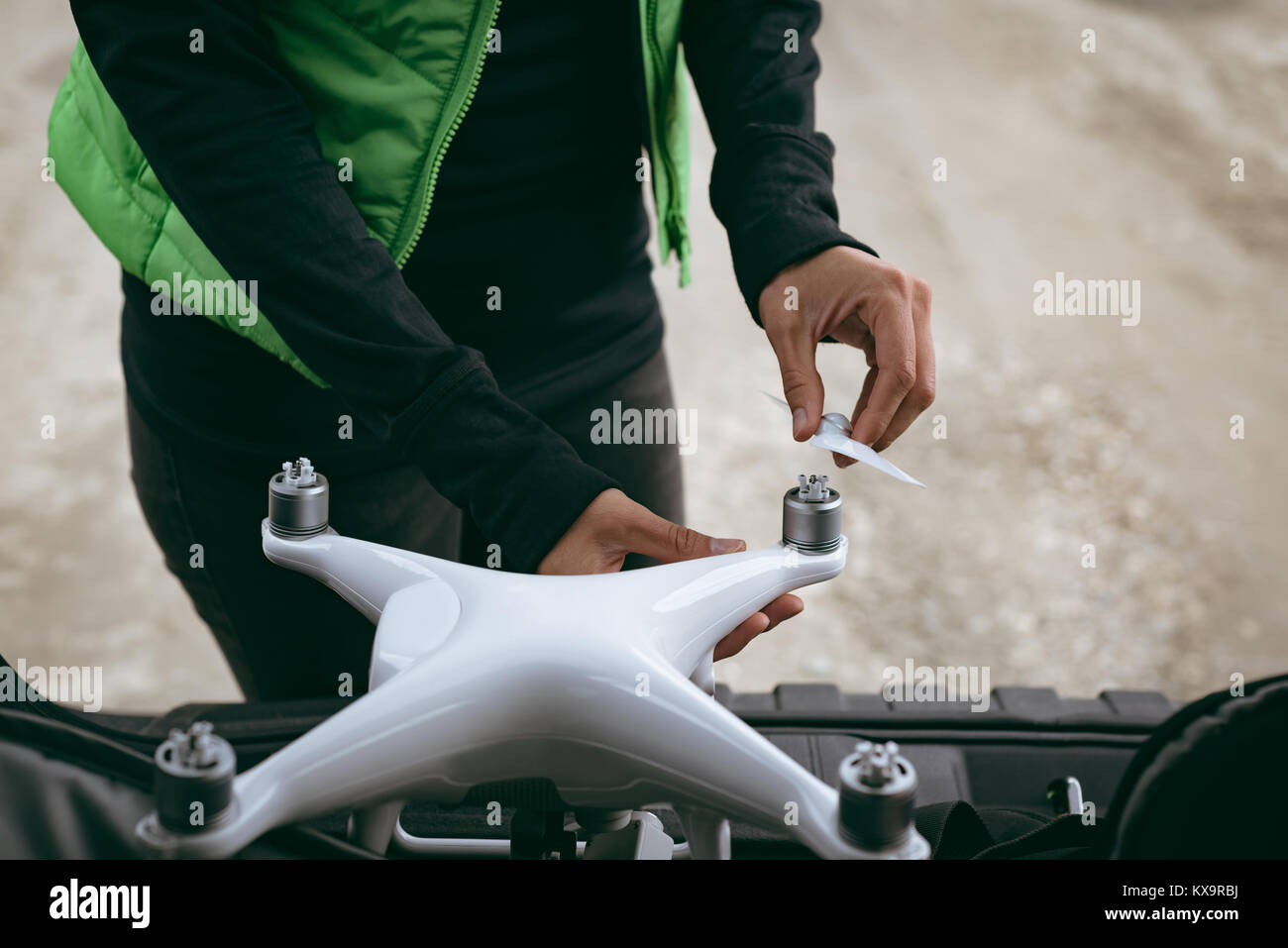 Woman installing propeller of drone before take off Stock Photo - Alamy