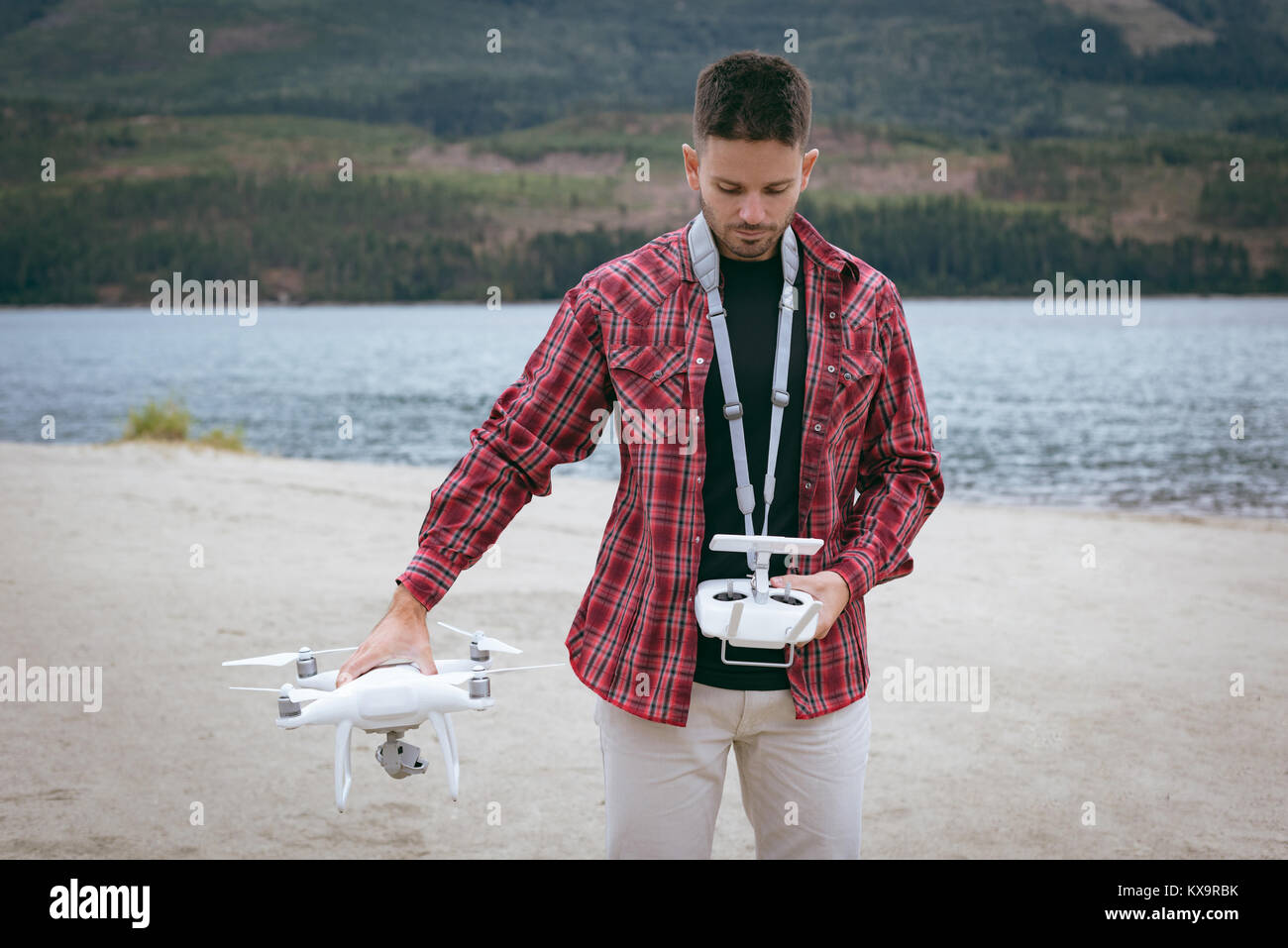 Man holding drone and remote control Stock Photo - Alamy