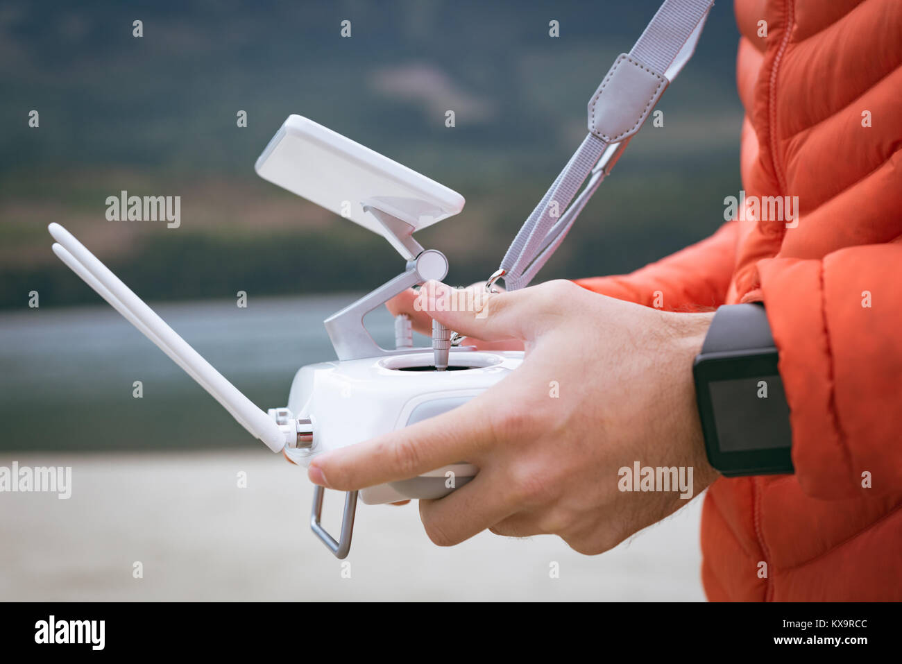 Two male hands holding a remote controller Stock Photo - Alamy