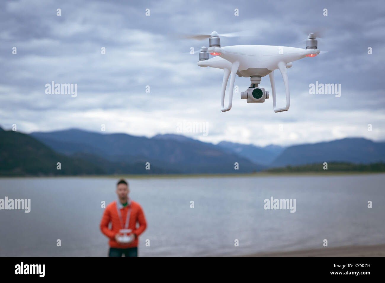 Man operating drone flying by remote control Stock Photo - Alamy