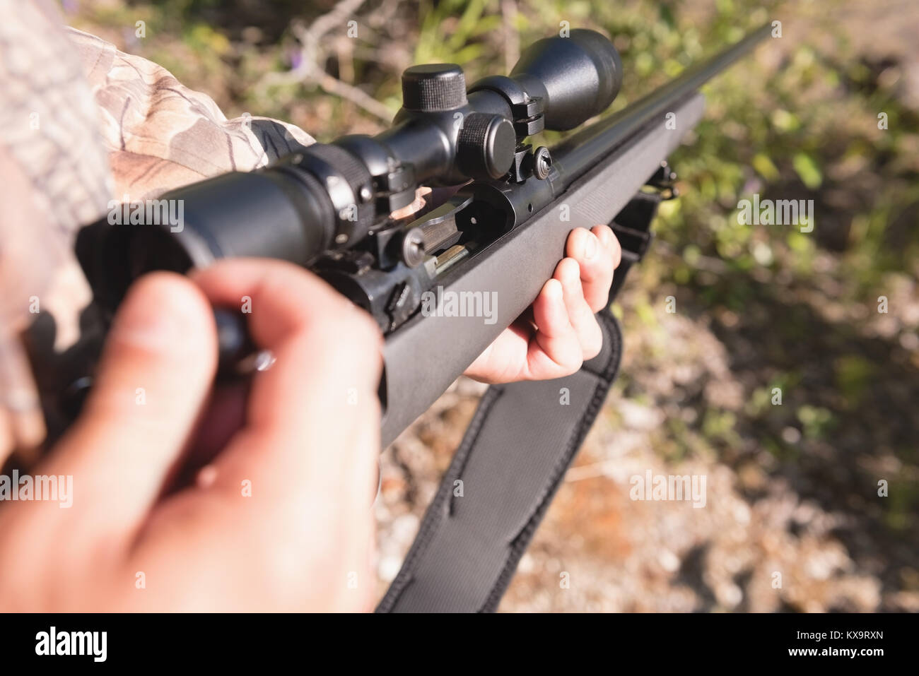 Hunter ready to shoot with sniper rifle Stock Photo - Alamy