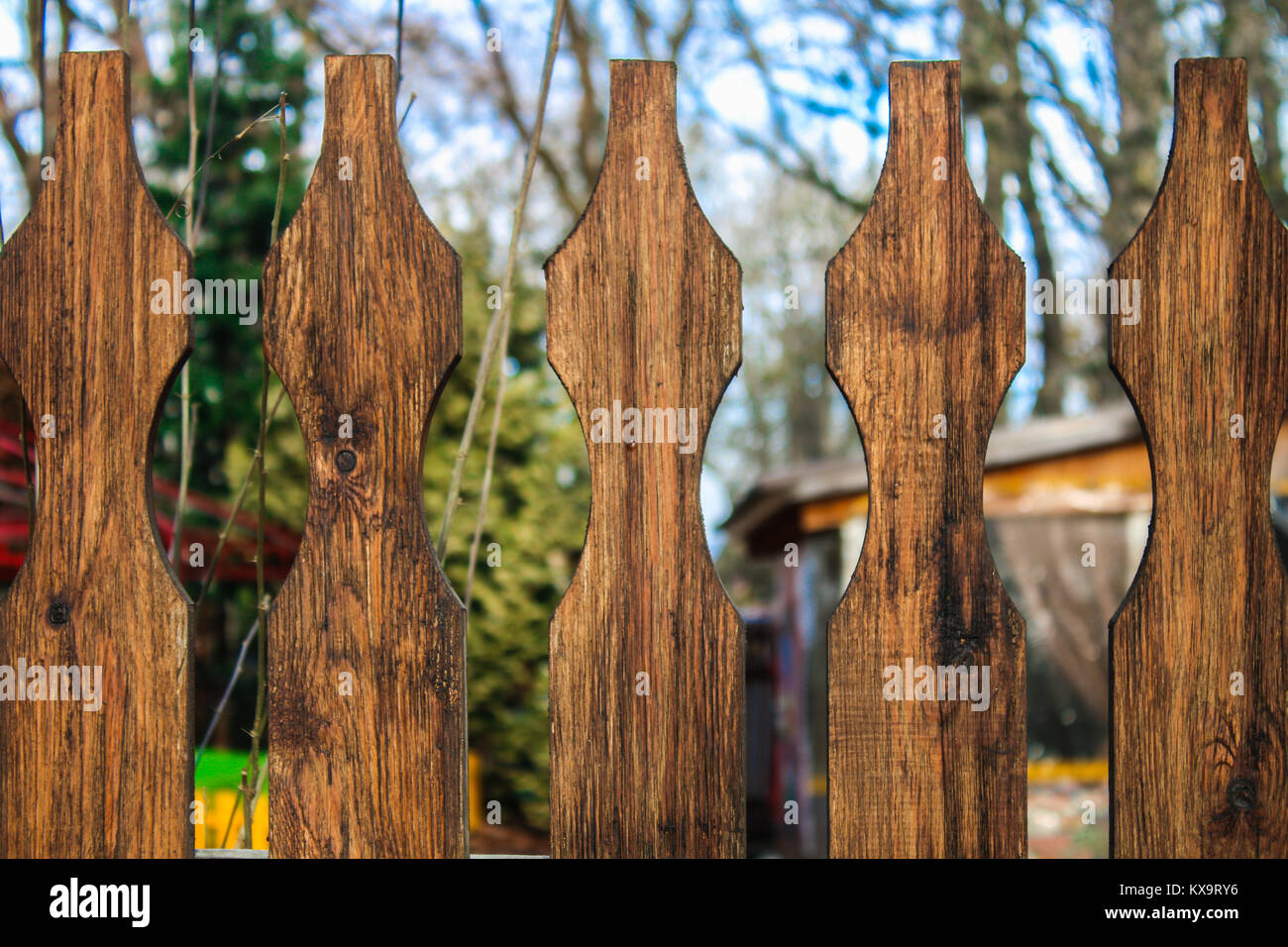Element of a brown wooden fence consisting of separate boards with a ...