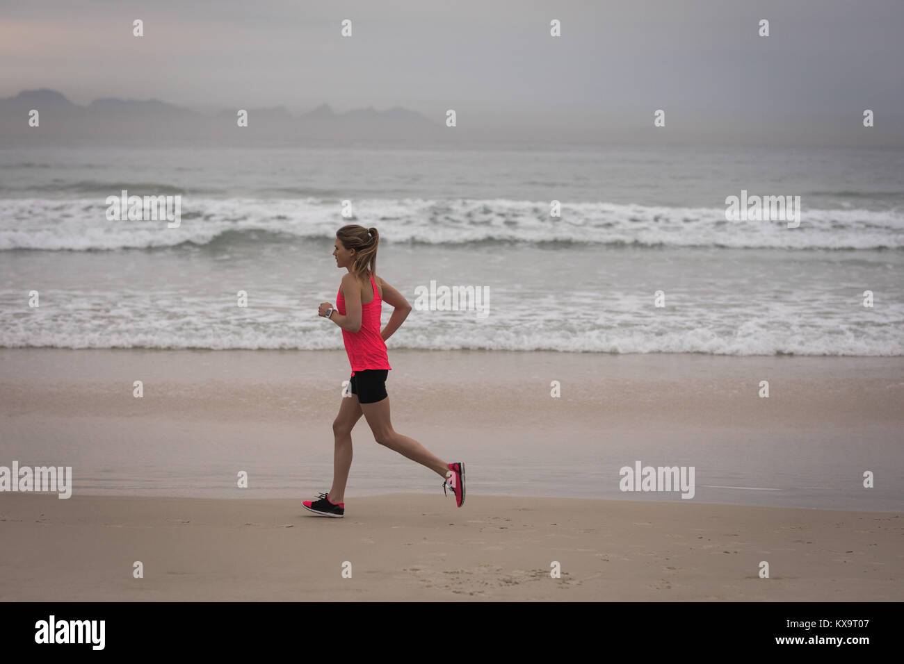 Young woman running beach on hi-res stock photography and images - Alamy