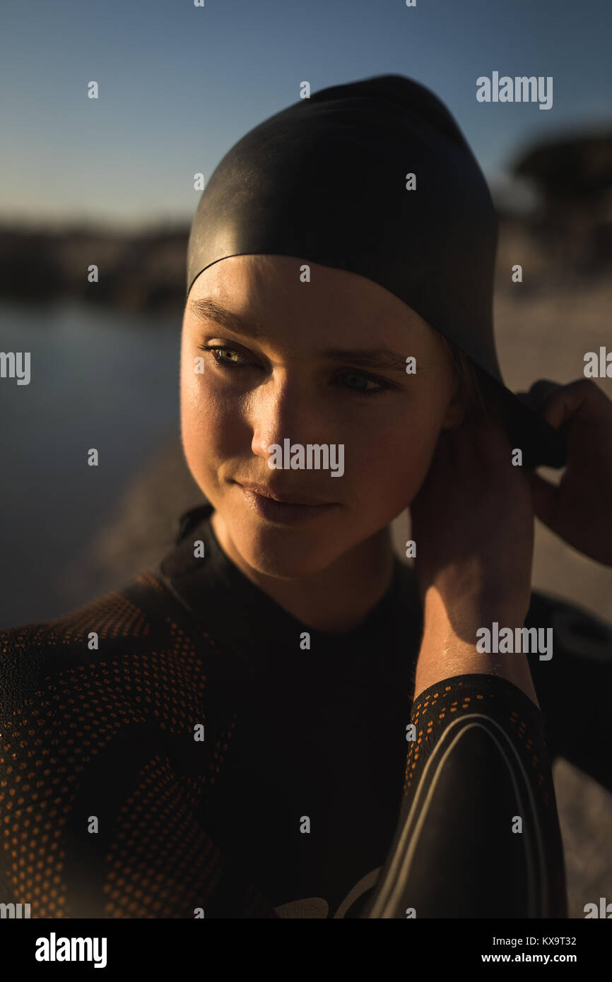 Woman getting ready to swim in the ocean at sunset Stock Photo - Alamy