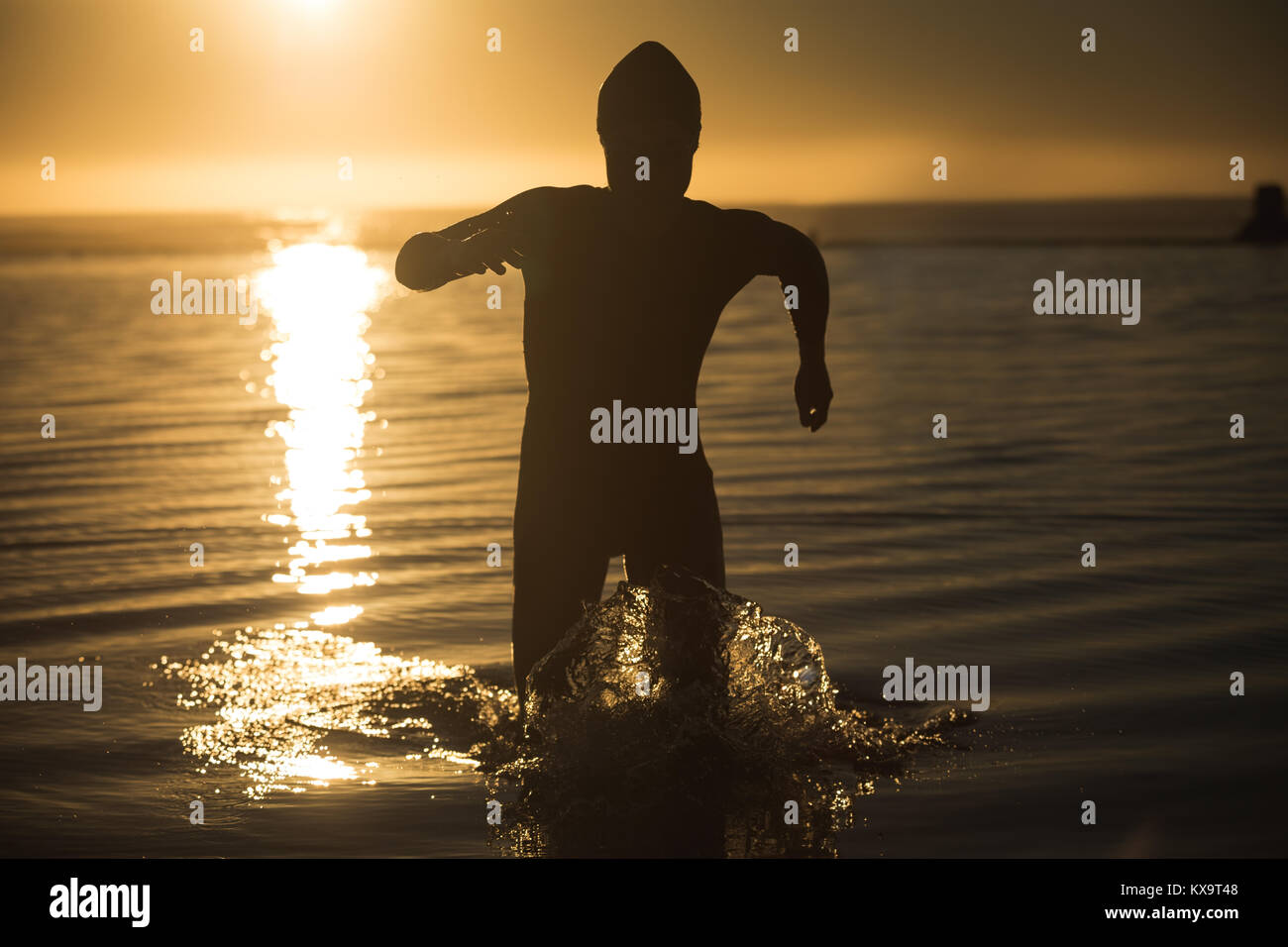 Woman running in sea water Stock Photo - Alamy