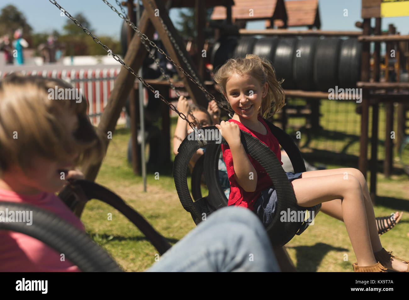 Children swinging hi-res stock photography and images - Alamy