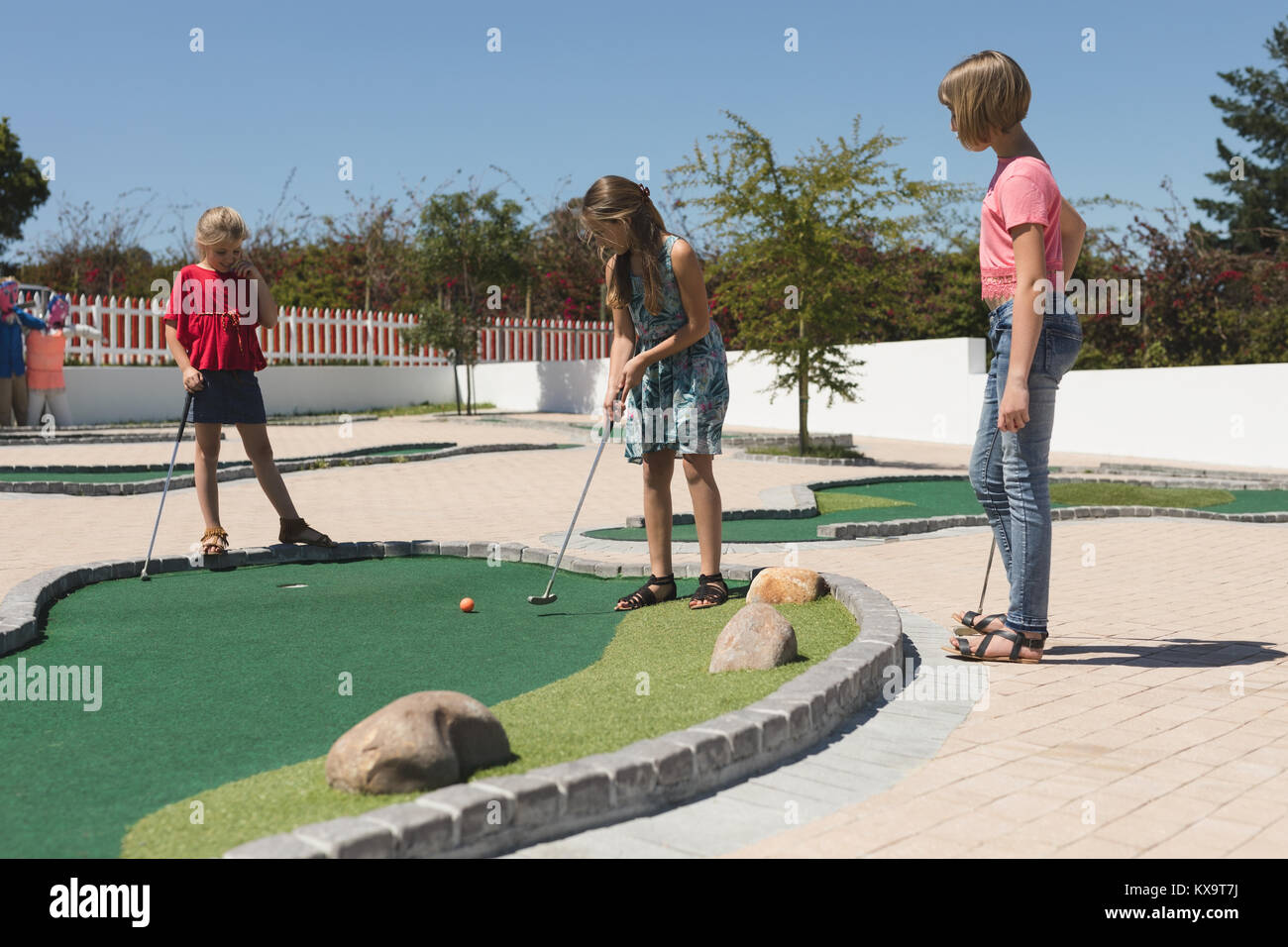 Children playing golf in playground Stock Photo - Alamy