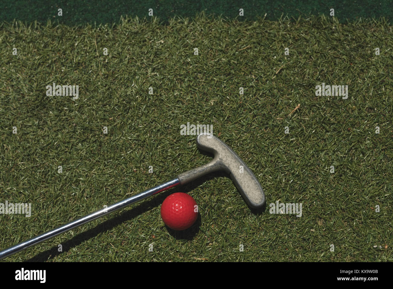 Golf ball with gold club Stock Photo - Alamy
