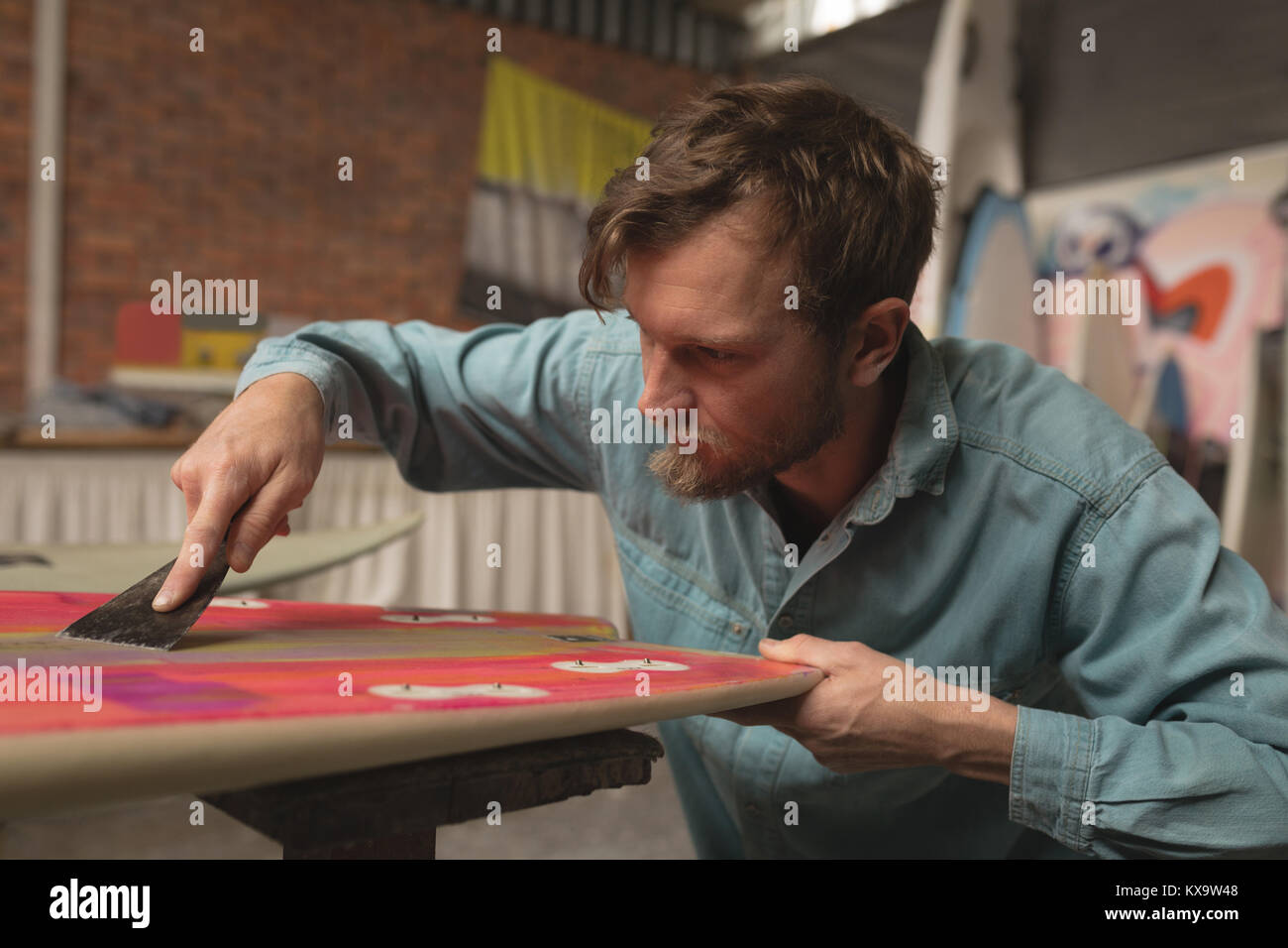 Male worker making surfboard Stock Photo - Alamy