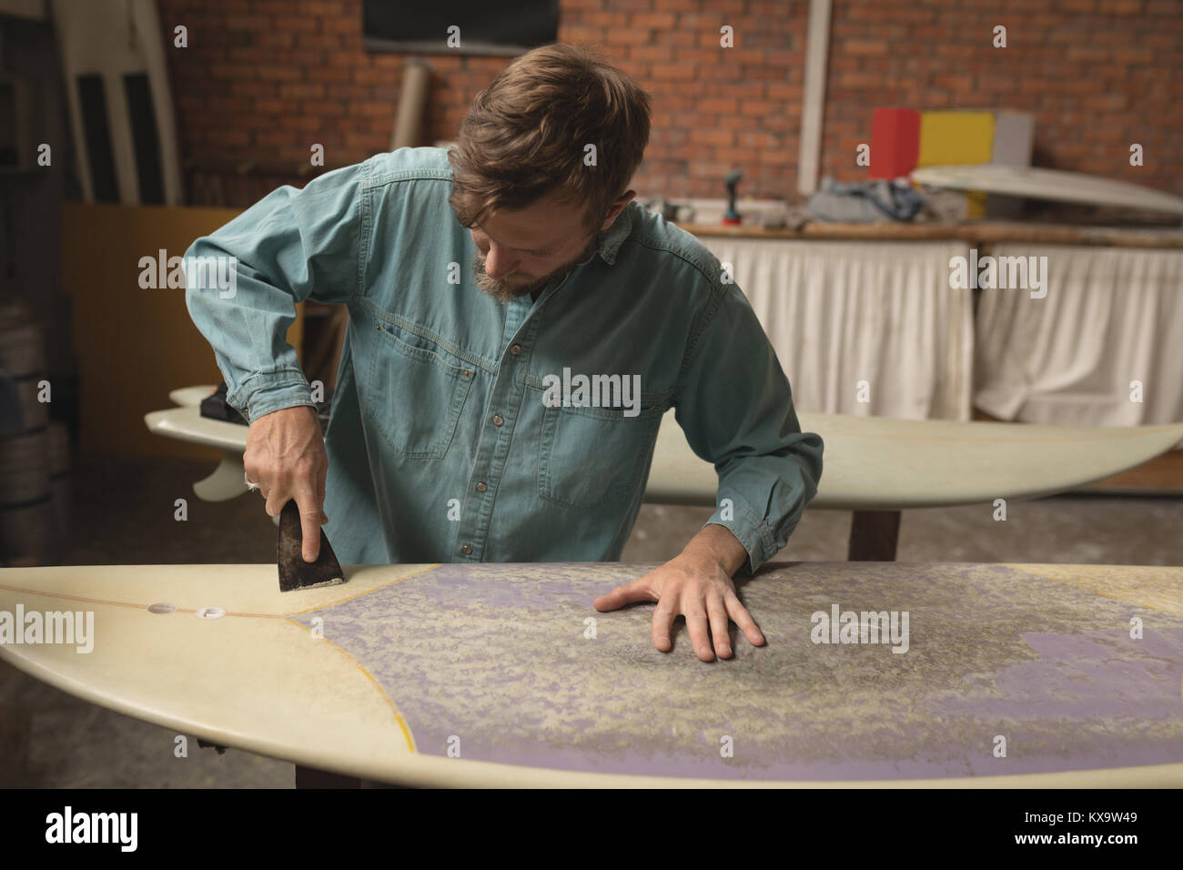 Male worker making surfboard Stock Photo - Alamy