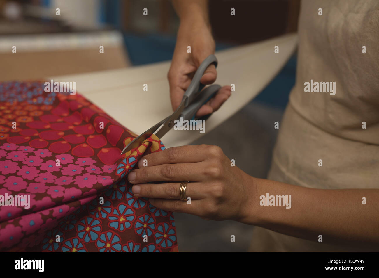 Female worker cutting design clothes with scissor Stock Photo - Alamy