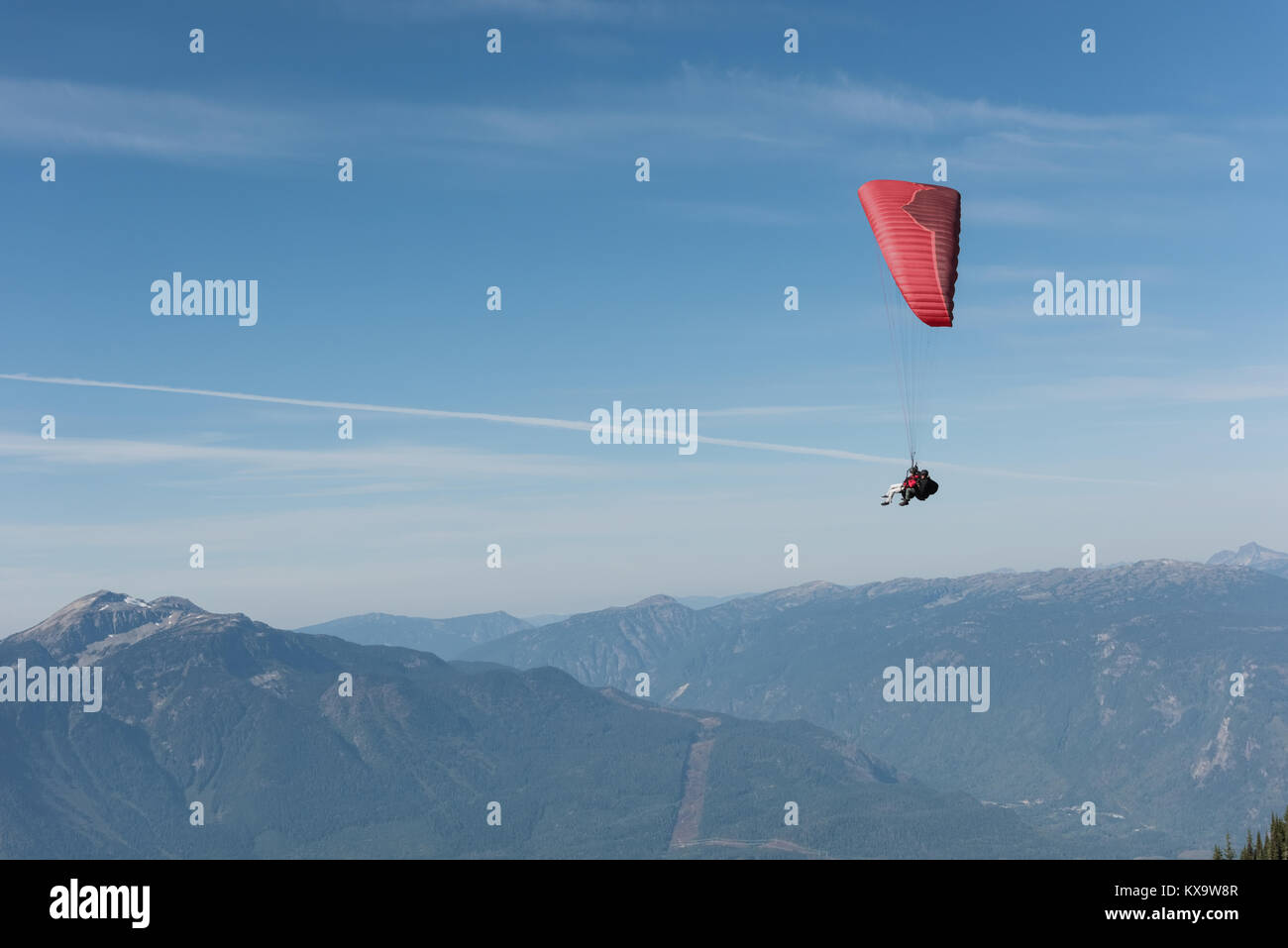 Paraglider flying over beautiful mountain Stock Photo - Alamy