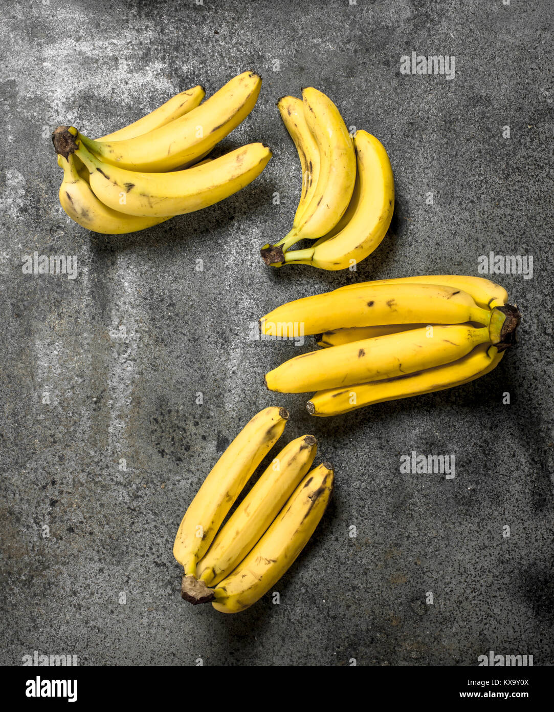 Fresh bunches of bananas. On a rustic background Stock Photo - Alamy