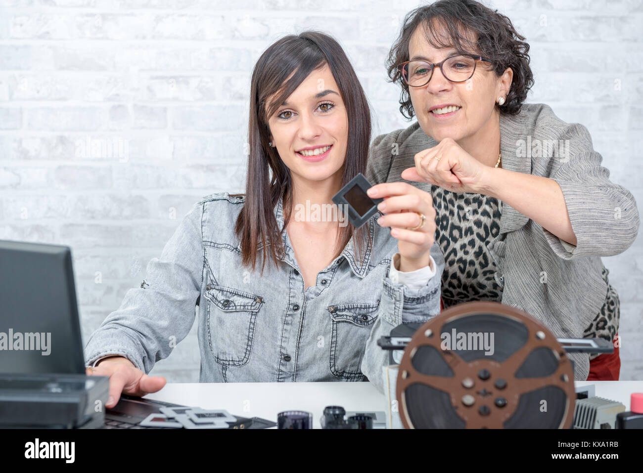 two women looking at old film slide Stock Photo - Alamy