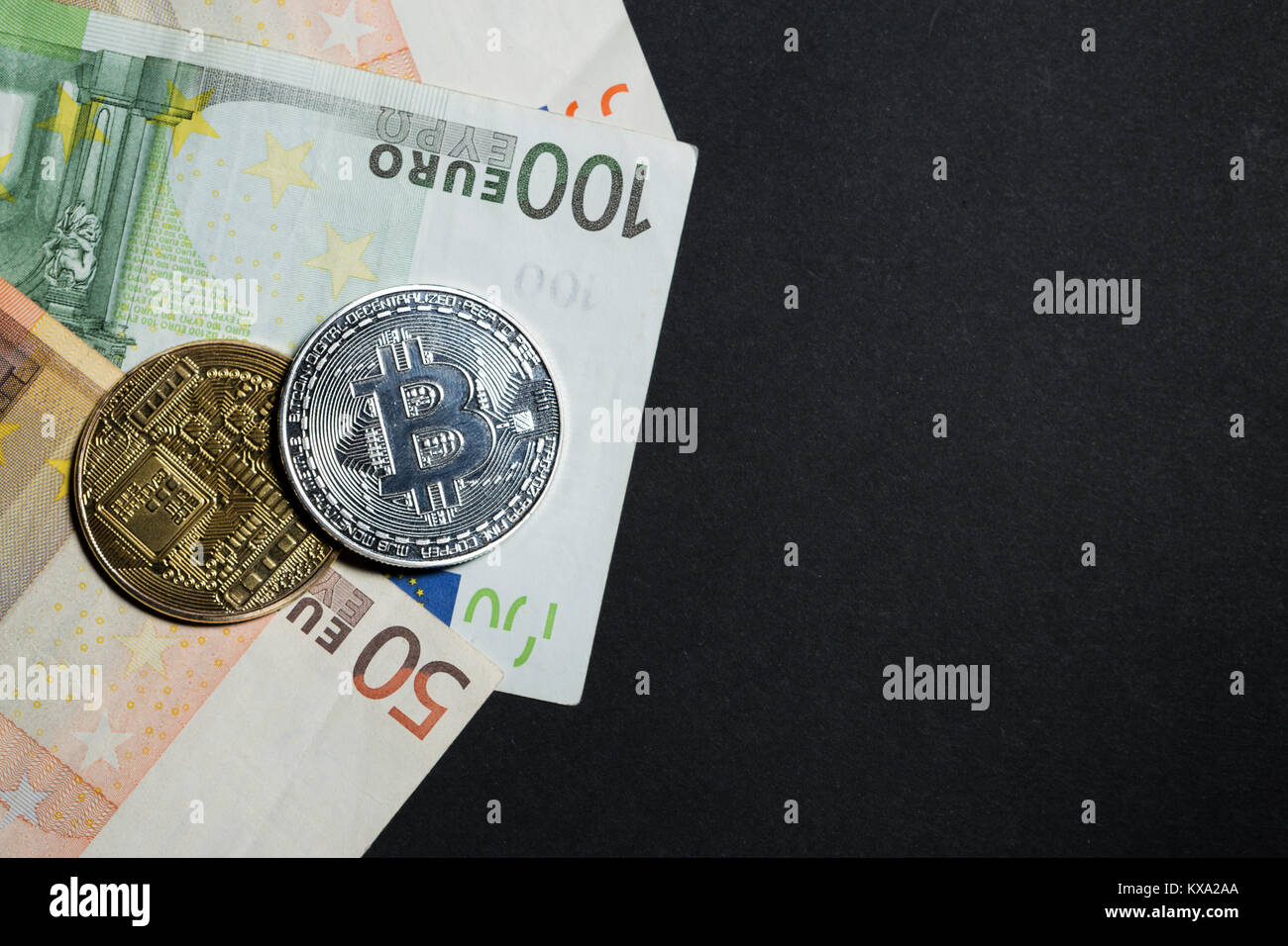 Bitcoins on real euro paper banknotes and black copy text area space ...