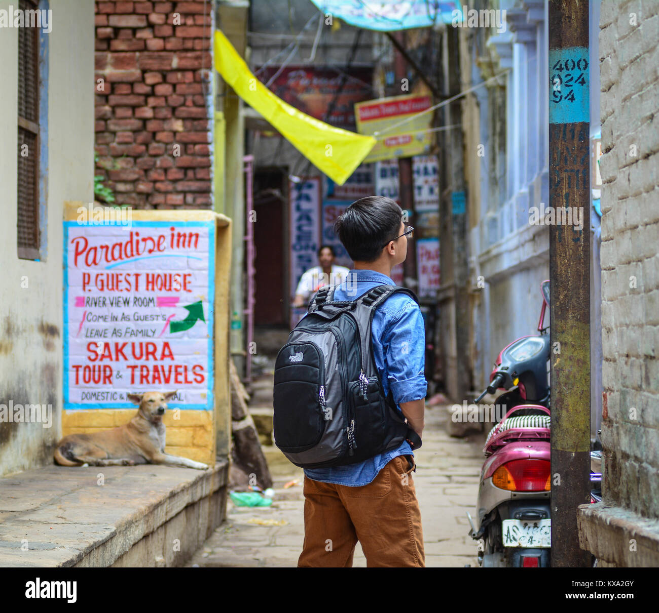 Varanasi, India - Jul 12, 2015. A young man walking on street in ...