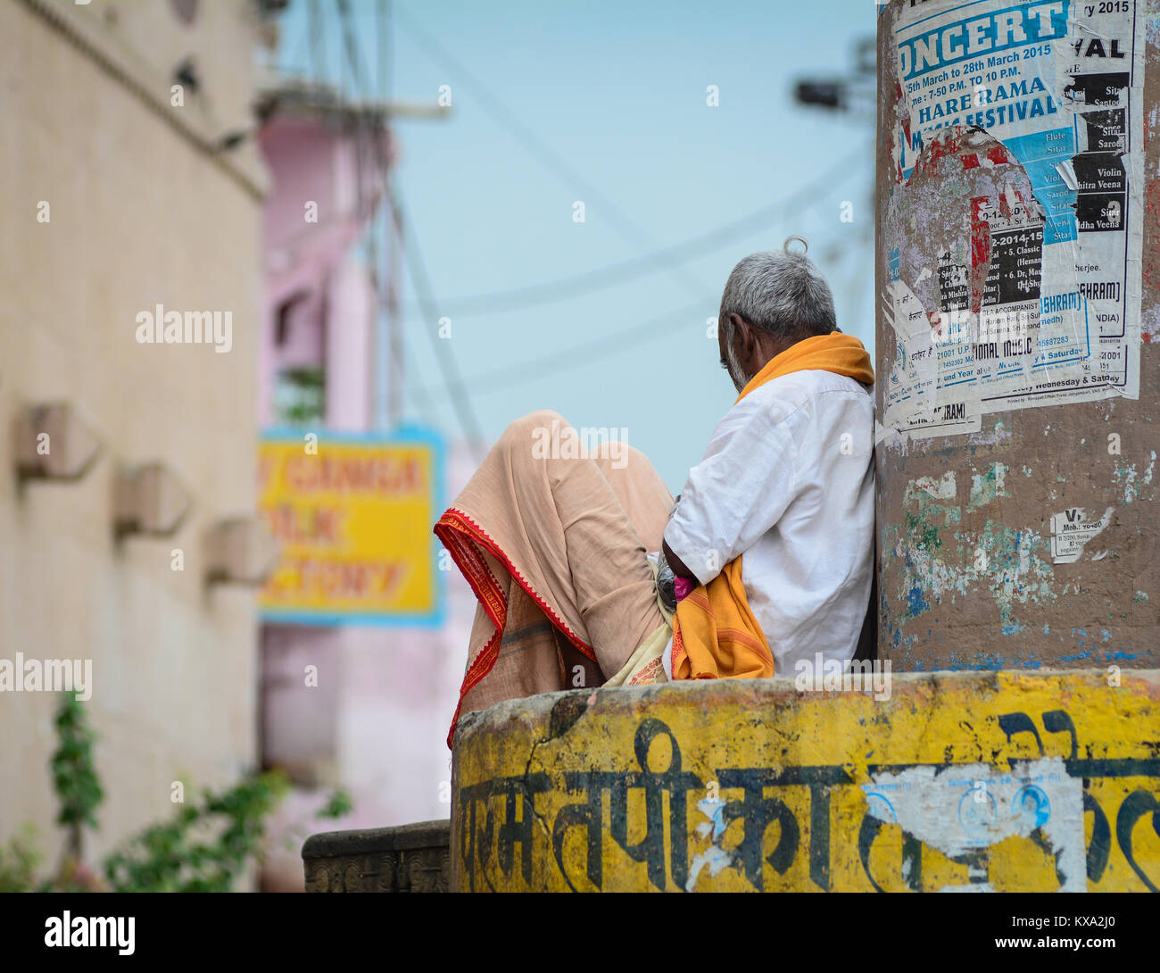 Varanasi, India - Jul 12, 2015. A man sitting on street in Varanasi ...
