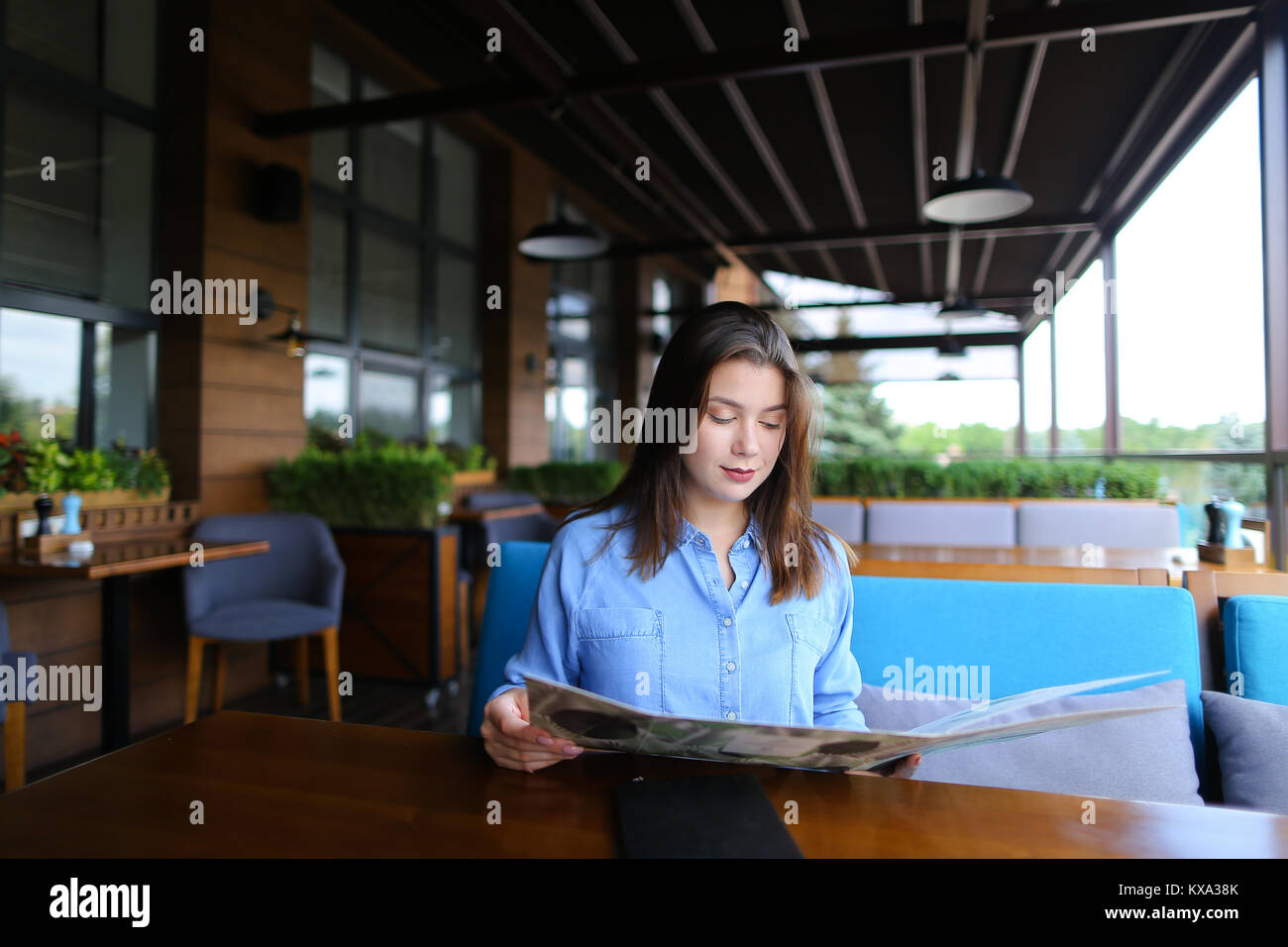 Pretty woman reading menu at restaurant with close up face Stock Photo ...