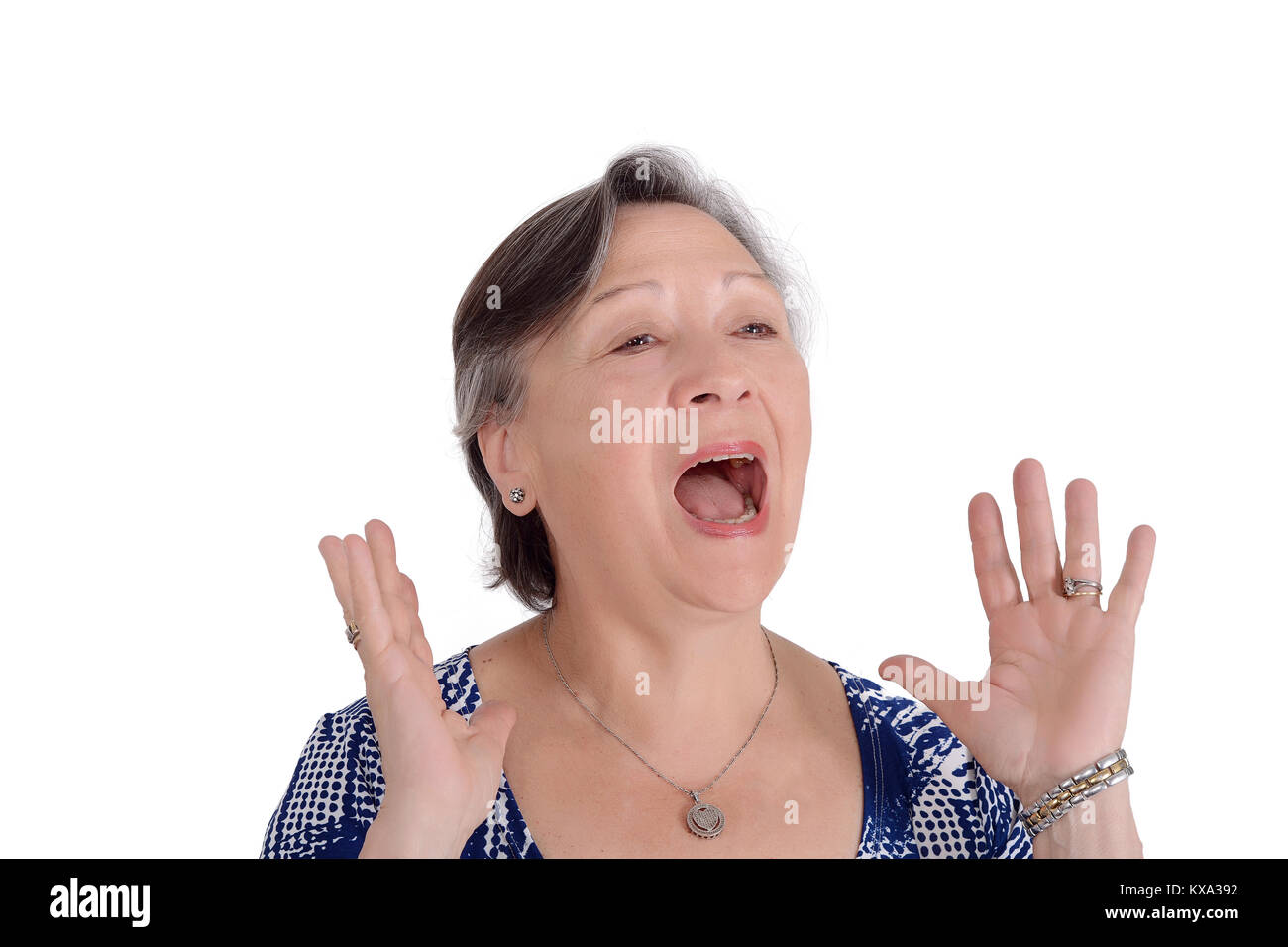 Portrait of elderly woman screaming with her hands on face. Isolated ...