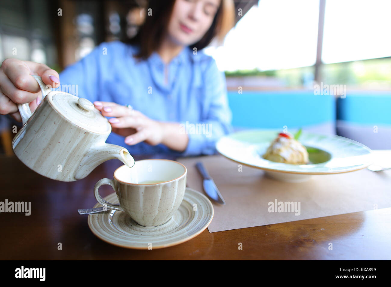 Charming restaurant customer pouring water into cup Stock Photo - Alamy